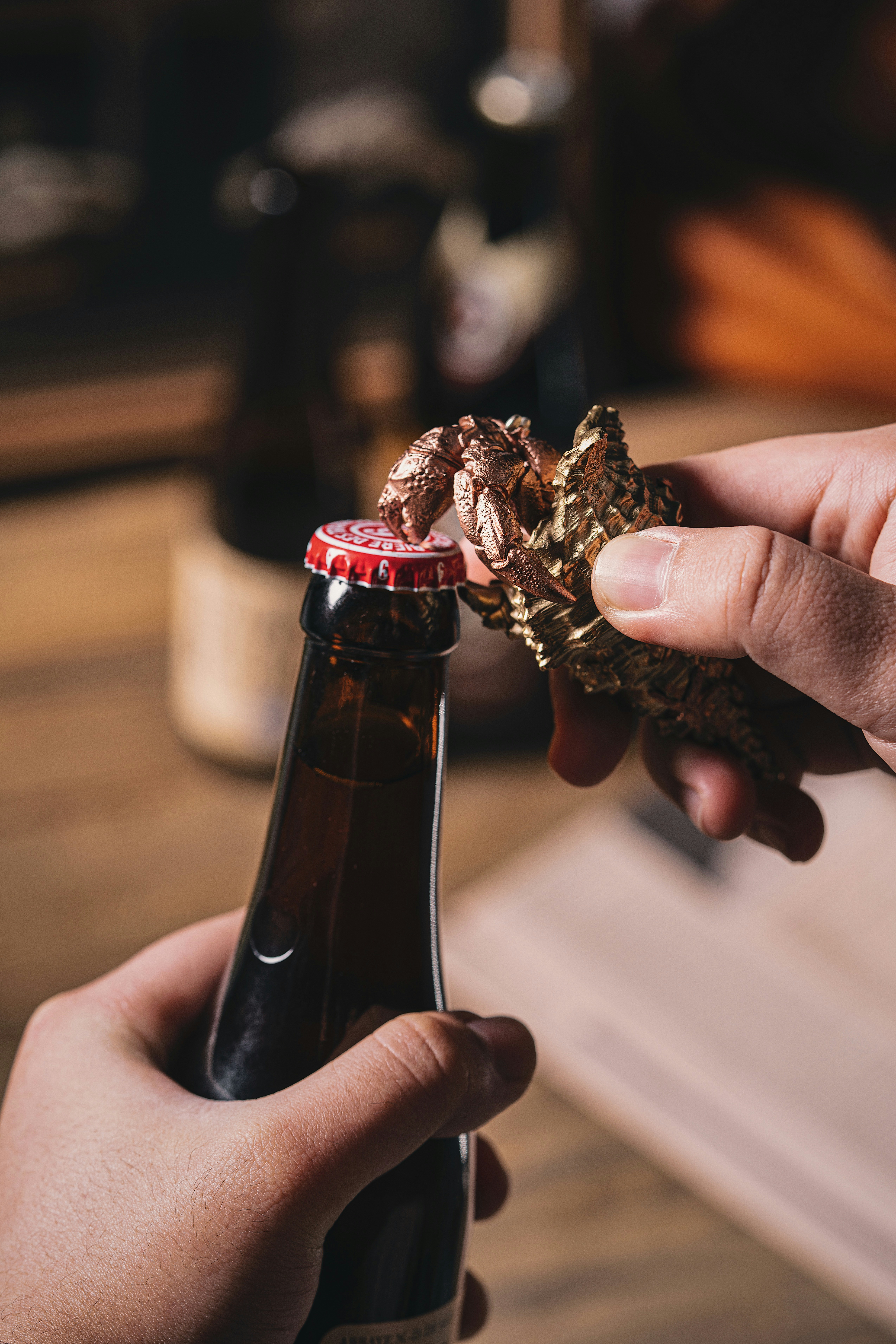 Cobbled ritual: twisting a pinecone lid onto a craft beer in a sunlit bar scene