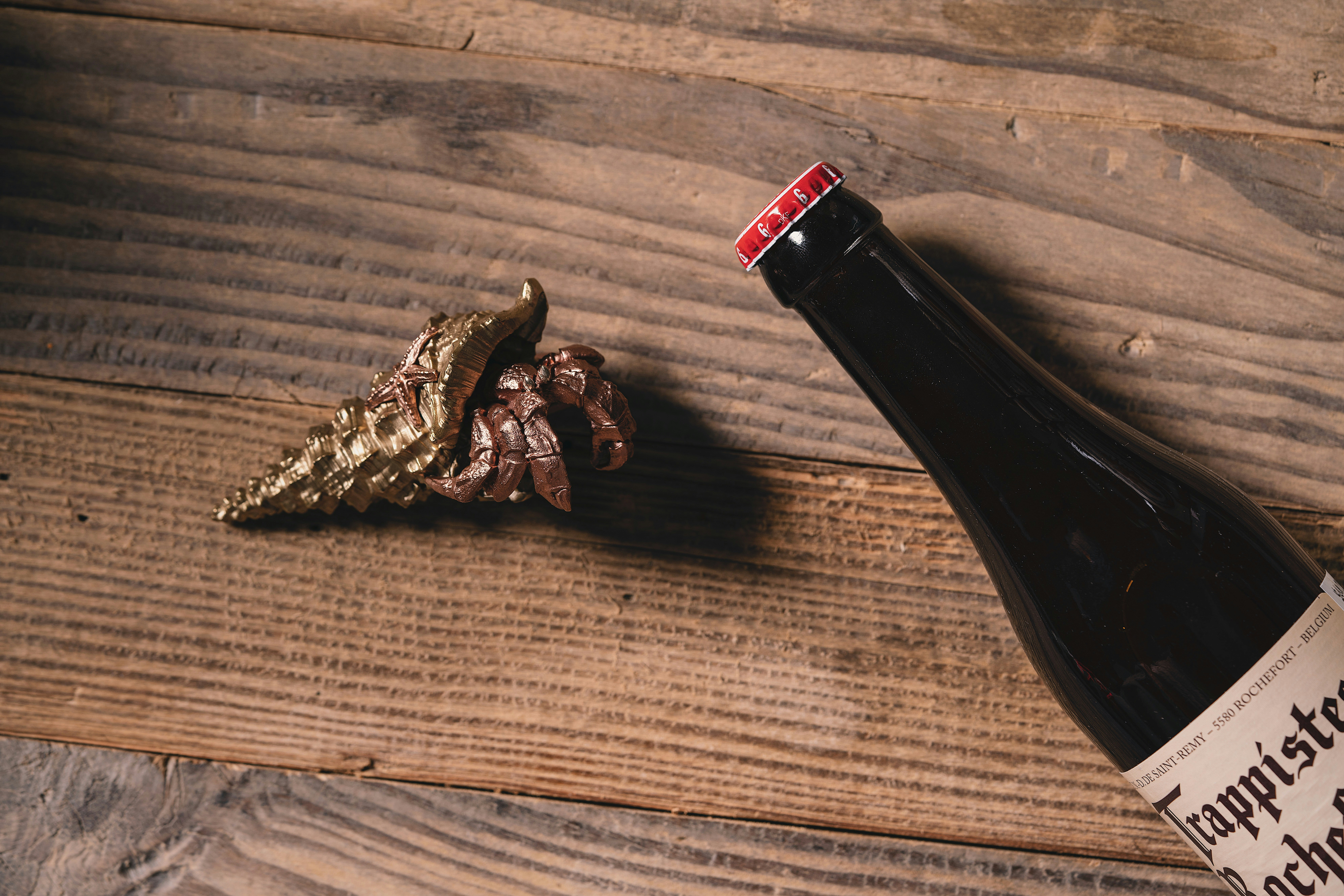 Trappist Bottle on Weathered Planks: Quiet Amber in Warm Woodgrain Light