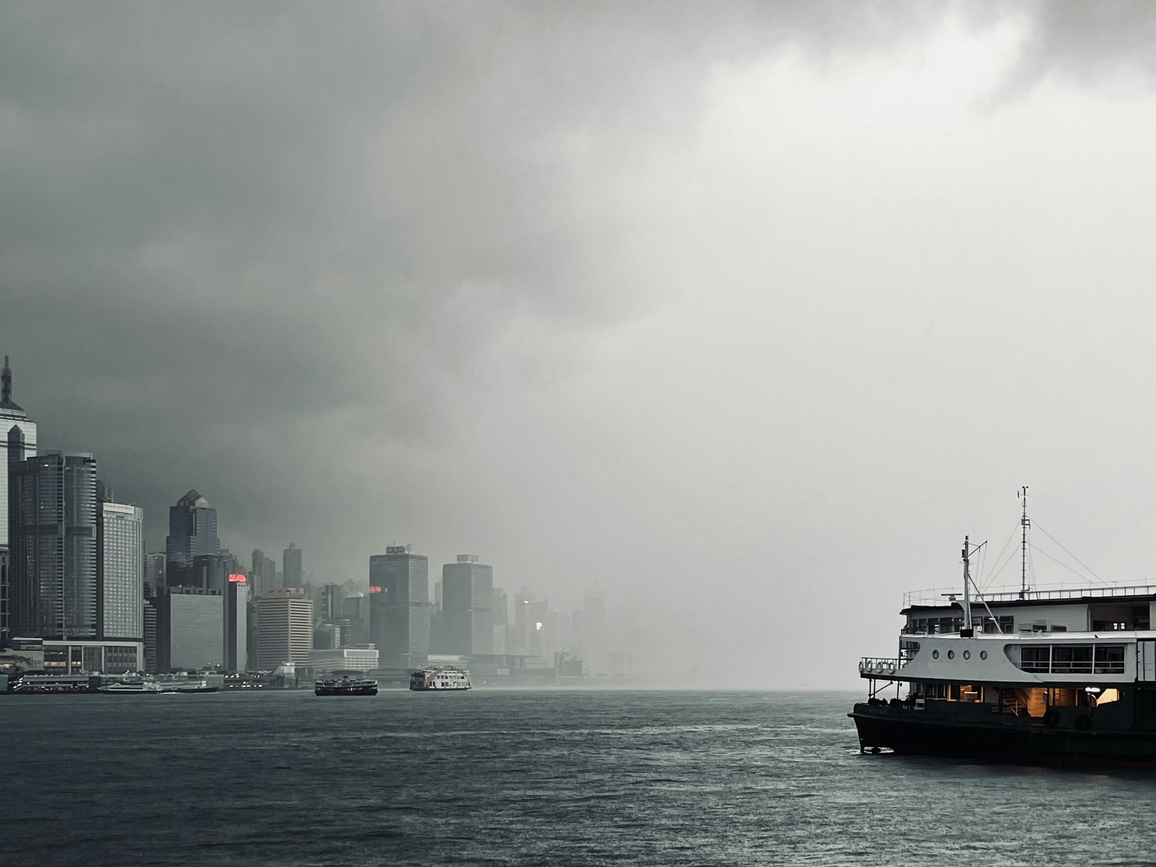 Mistbound Harbor: A Ferry Pauses Before a Fog-Washed Skyline