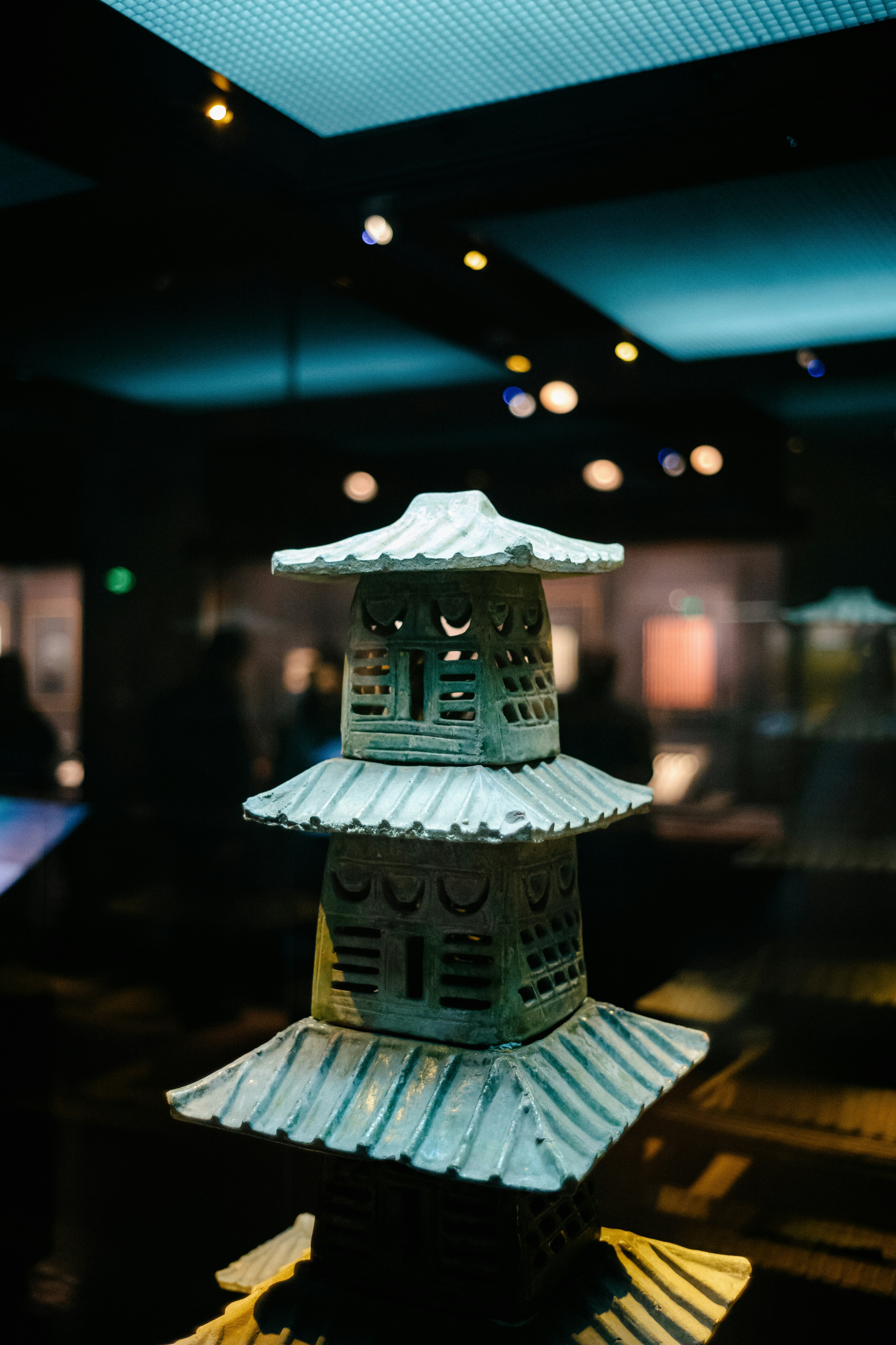 A three tiered pagoda in a dark room photo – Free Man Image on Unsplash
