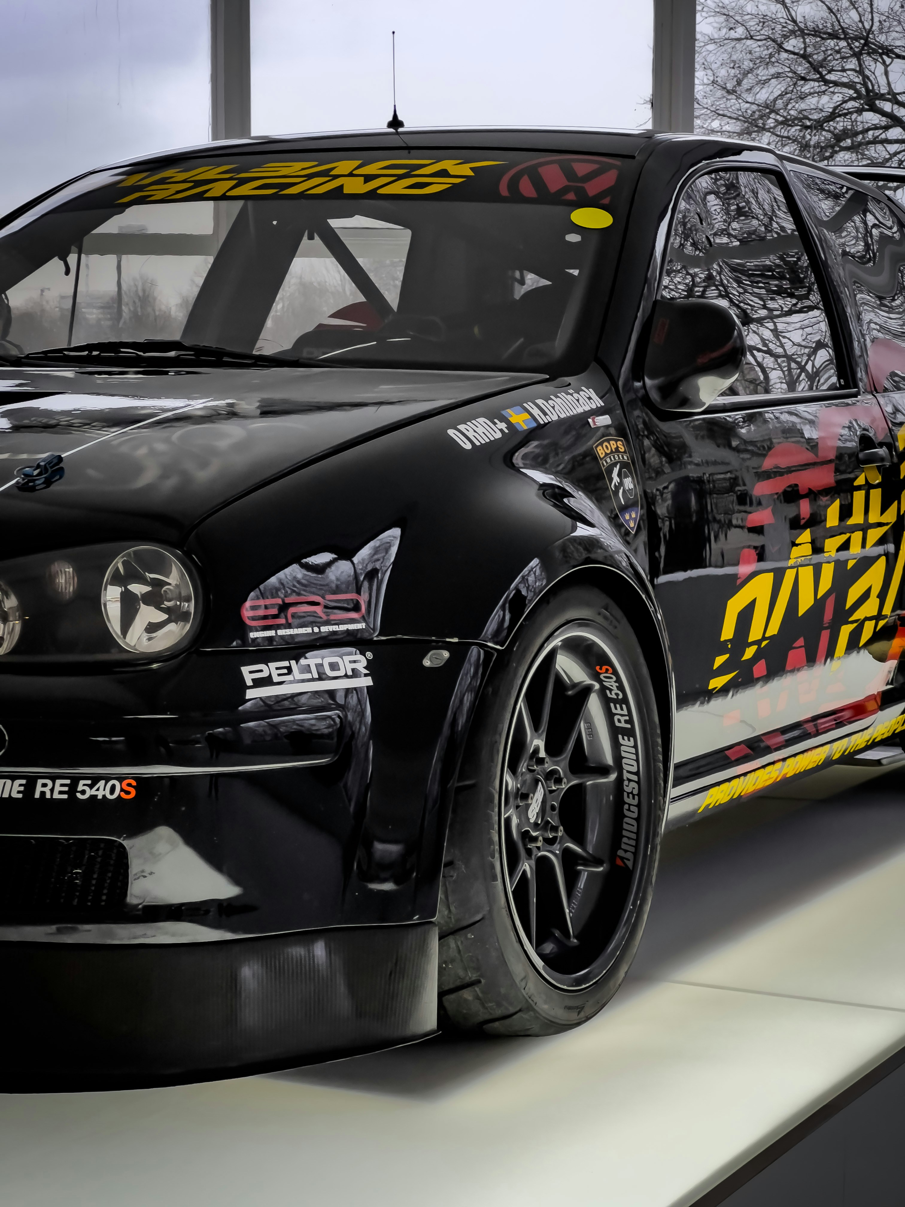 Ninja in Neon Stripes: A Black Racing Showpiece on Display