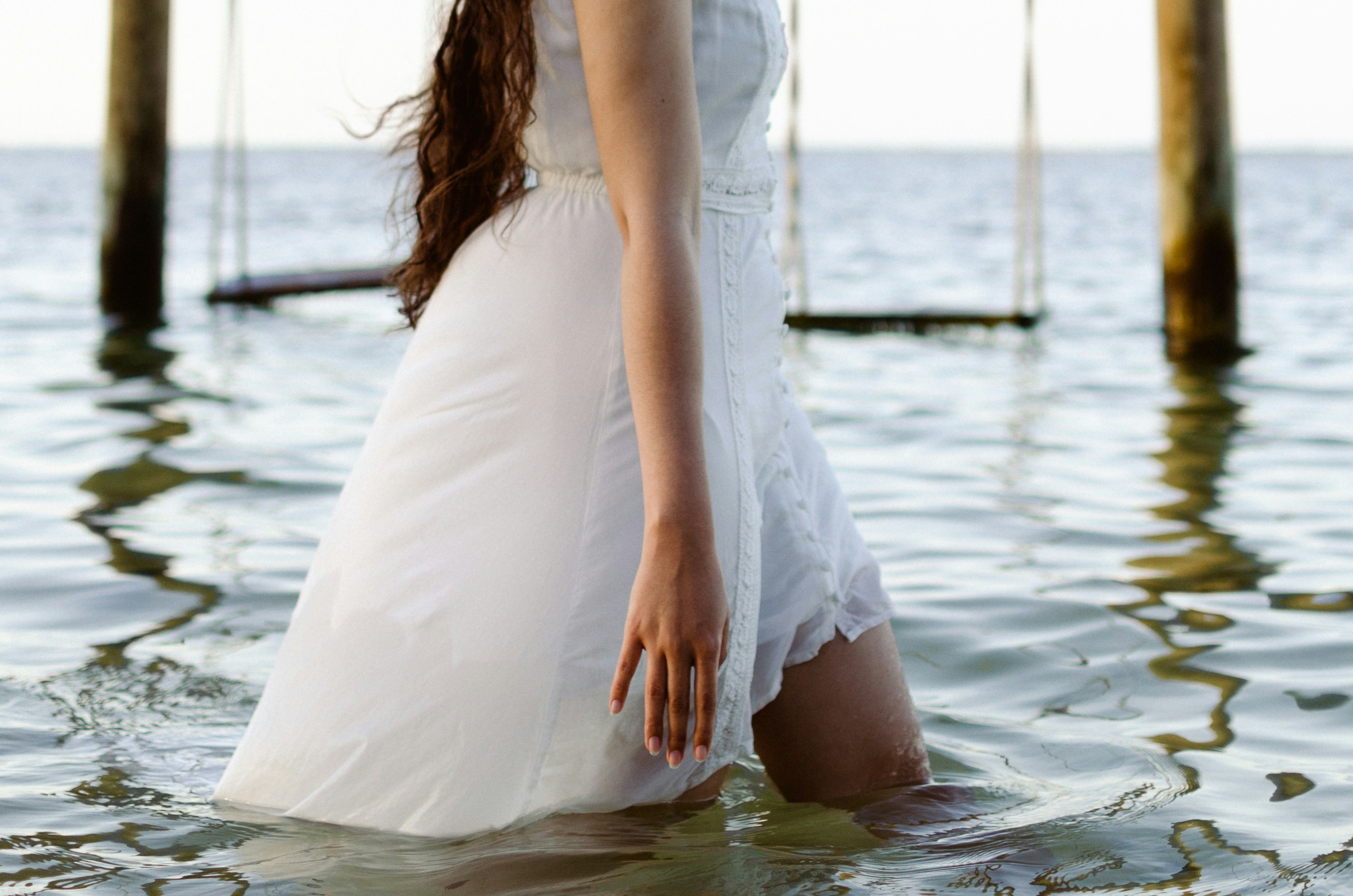 Tidebound Silhouette: White Dress at the Pier
