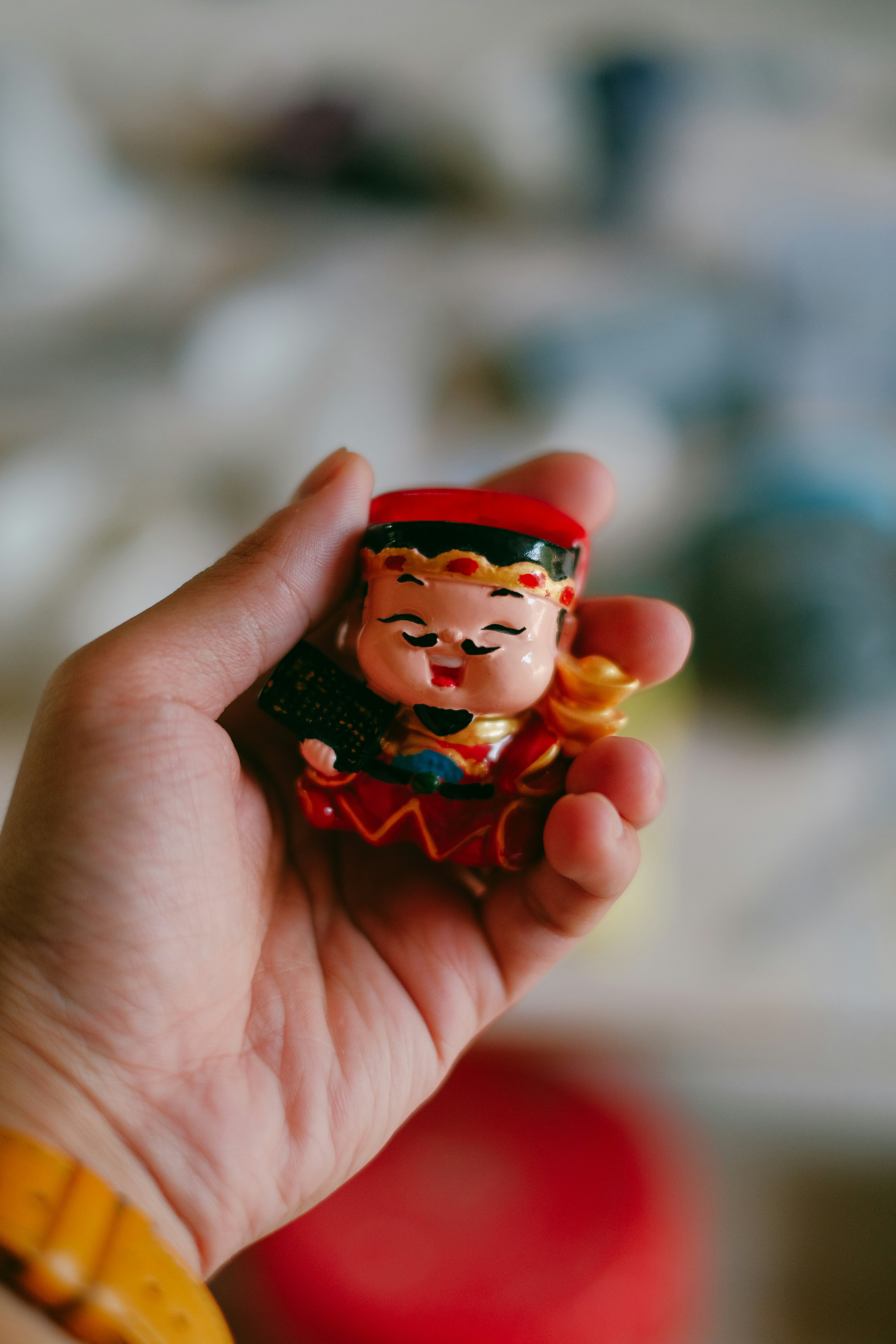 Hand-Held Charm: A Tiny Glazed Figurine in Quiet Focus