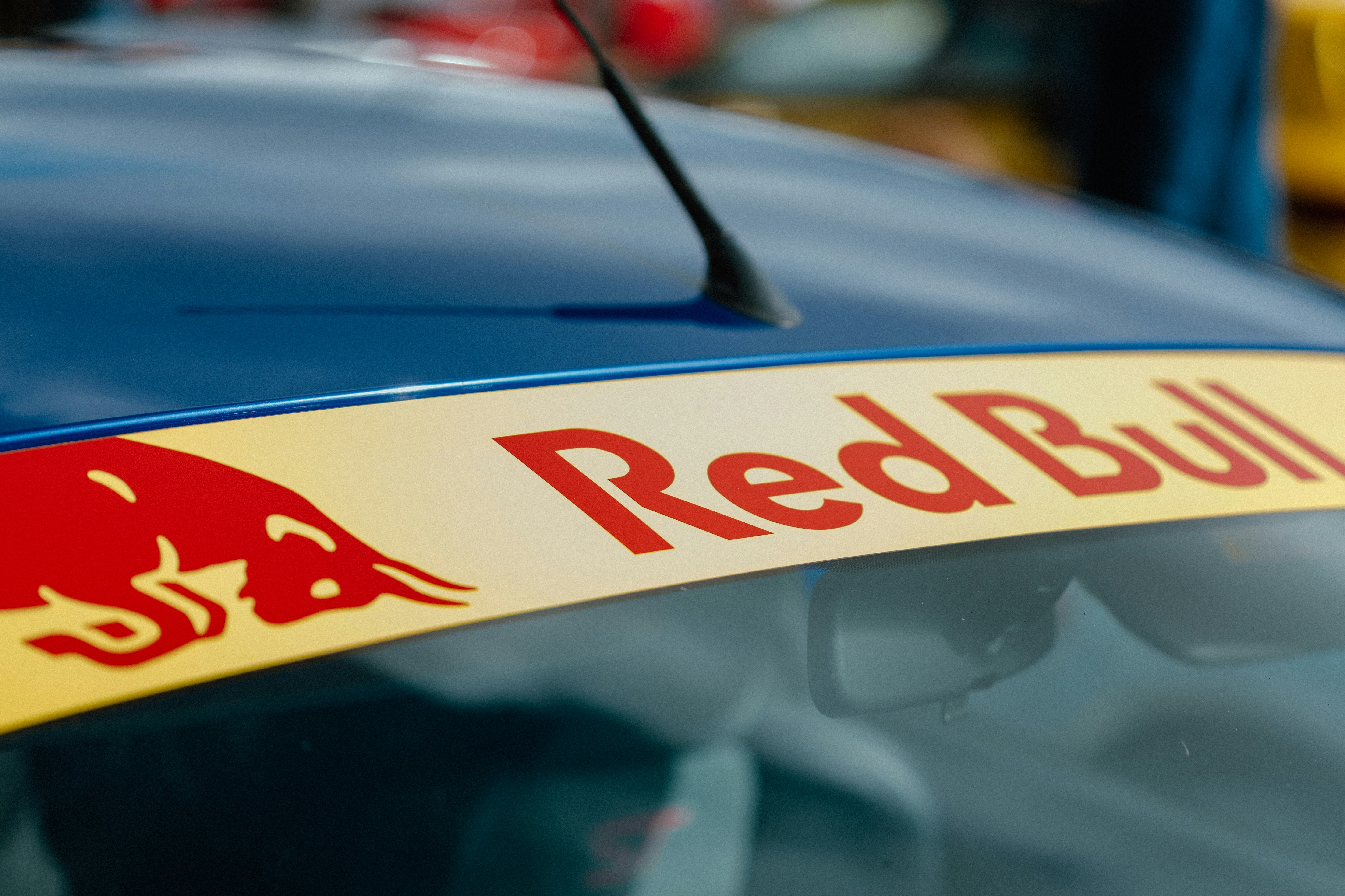 A close up of a red bull logo on a blue car photo – Free Red bull Image ...
