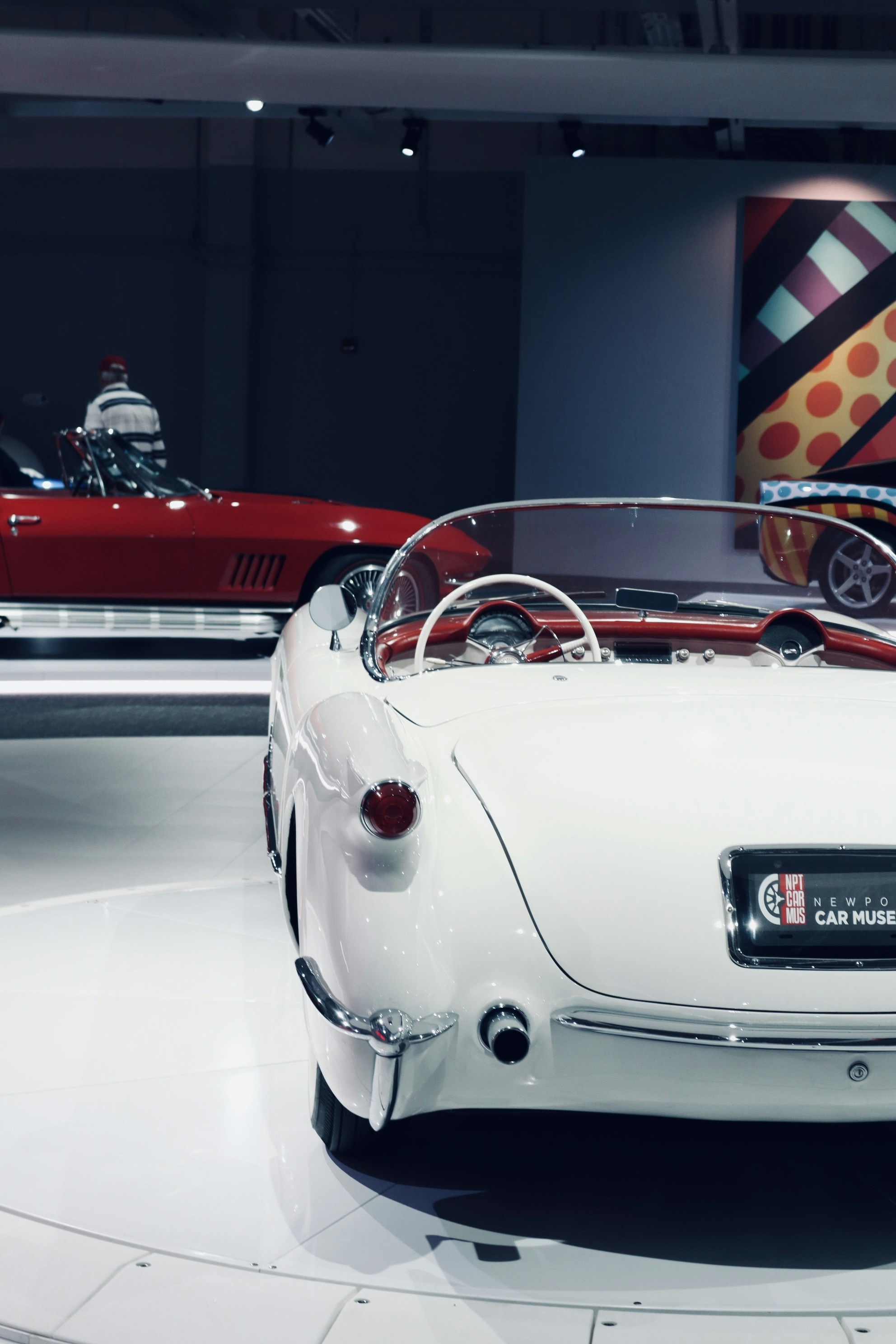 A white car on display at a car show photo – Free Person Image on Unsplash
