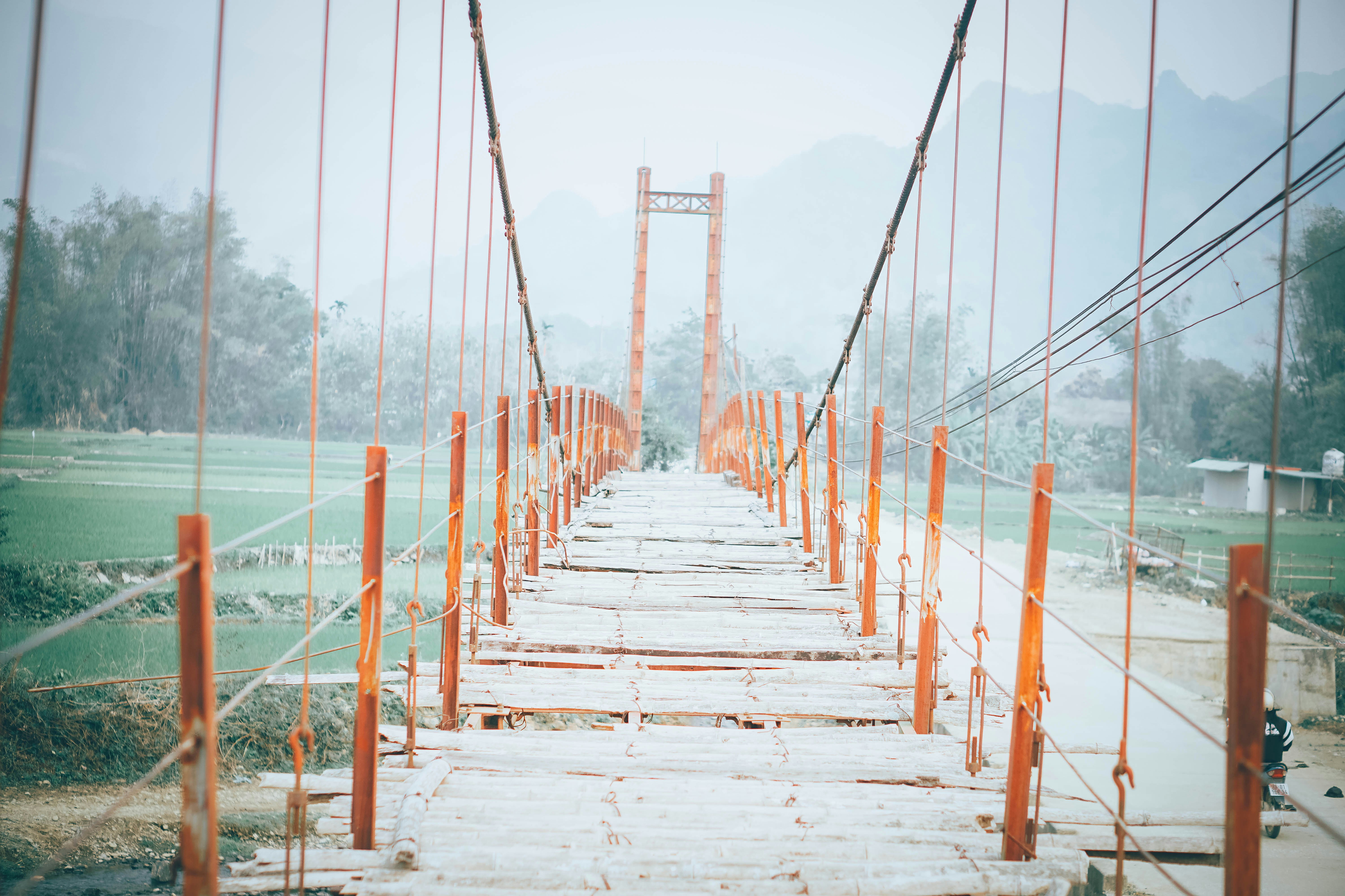 Suspended Path: Orange Ropes Leading to Distant Peaks