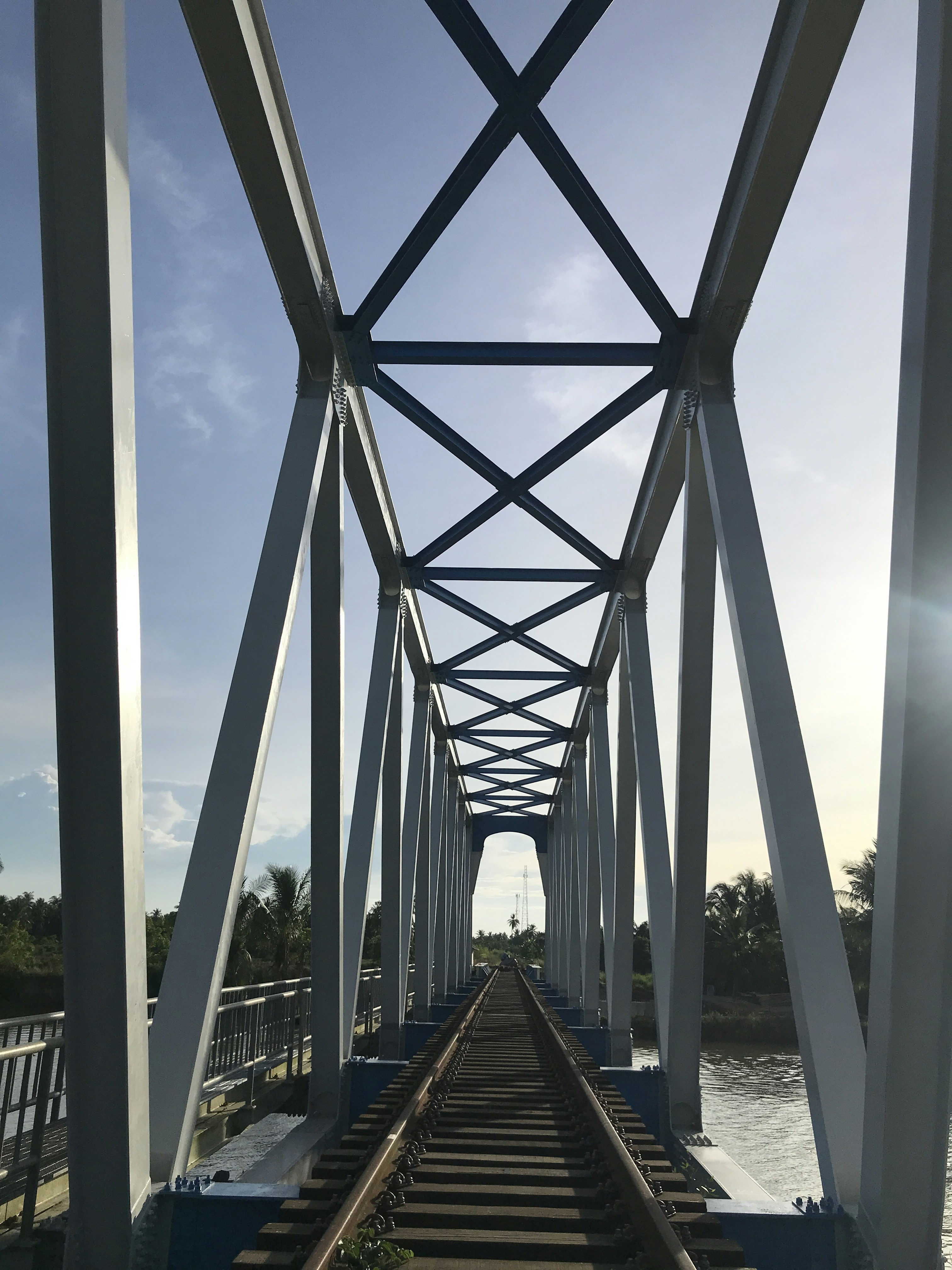 a train track going over a bridge over water