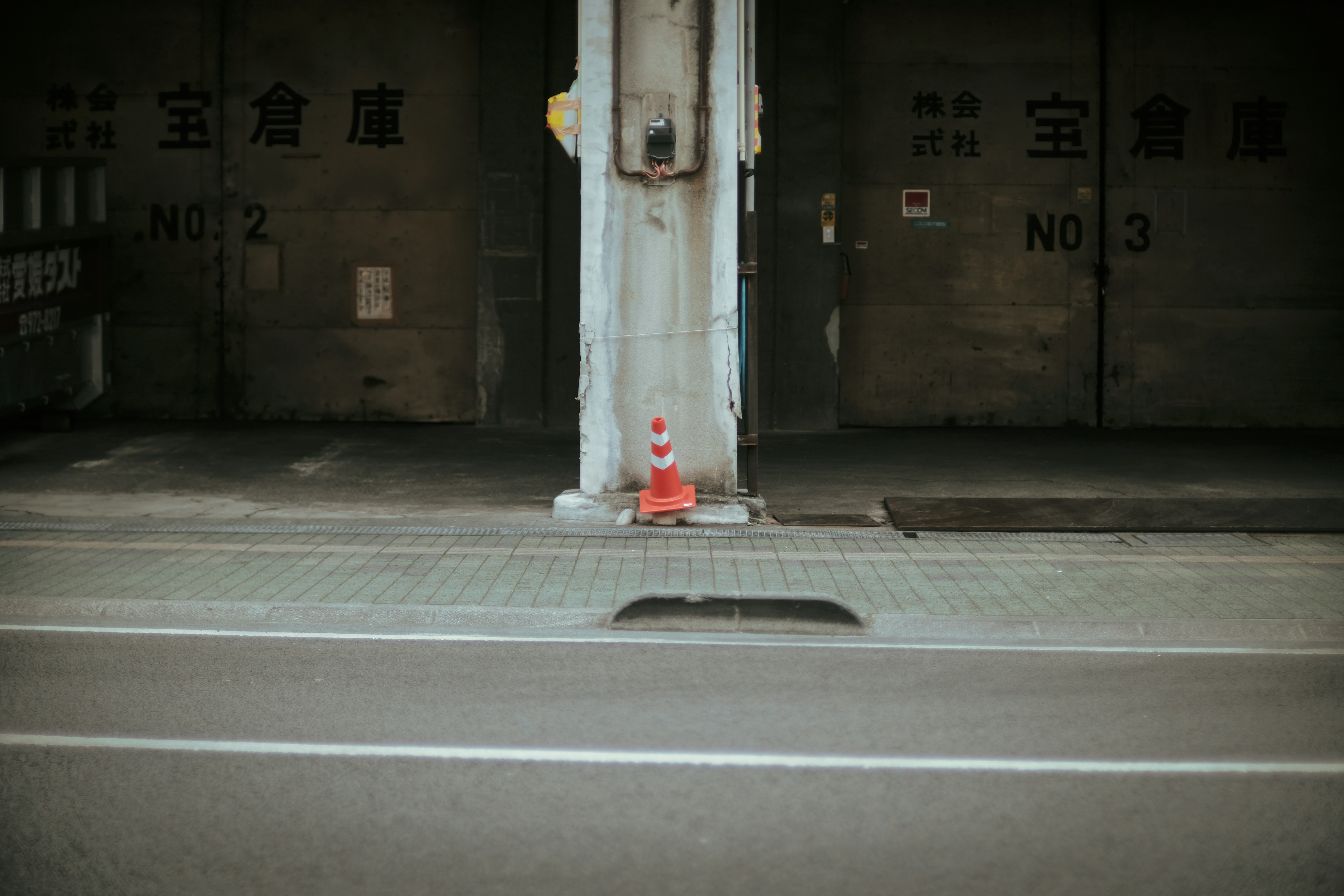 a red and white fire hydrant sitting on the side of a road
