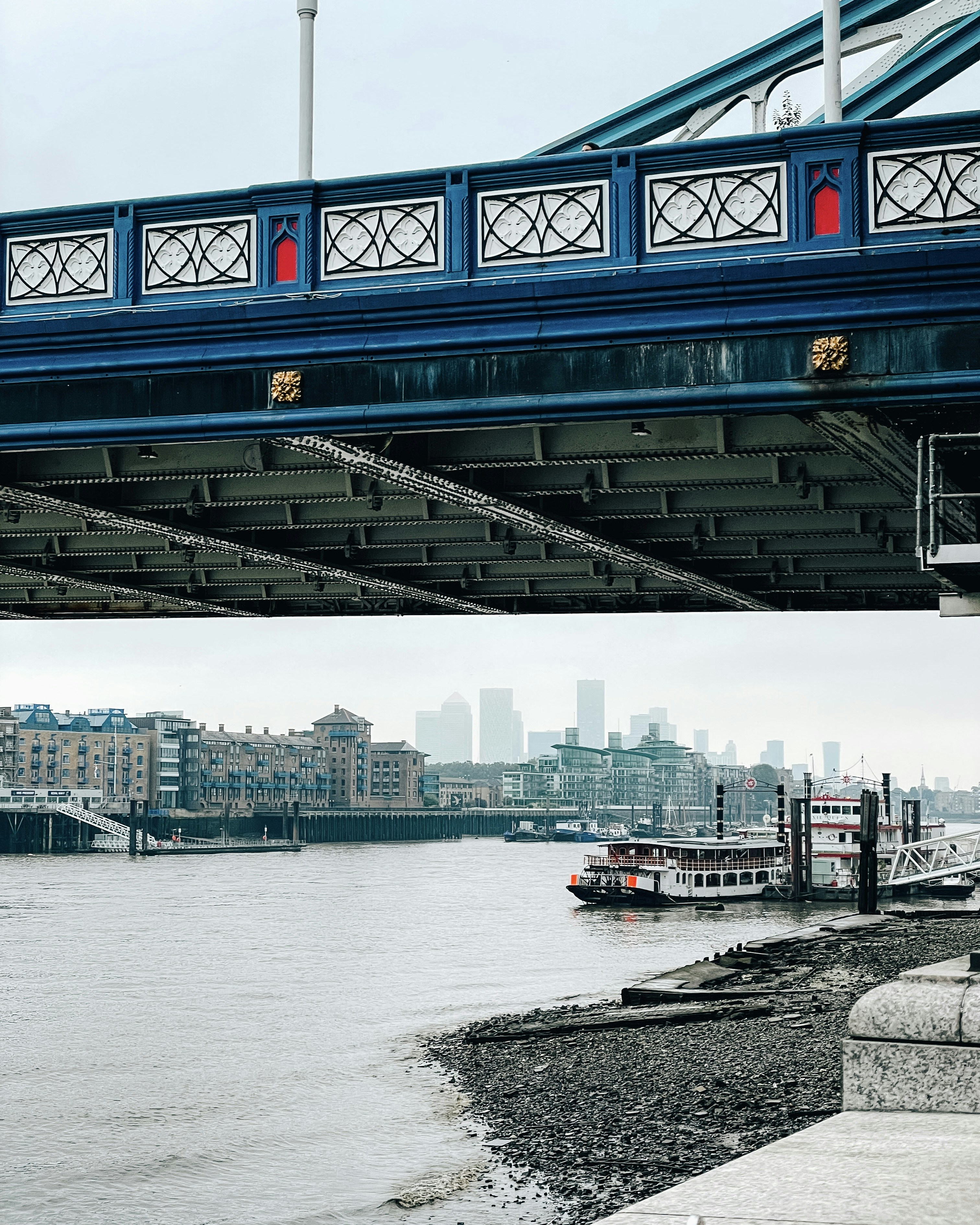 a bridge over a river with a boat in the water