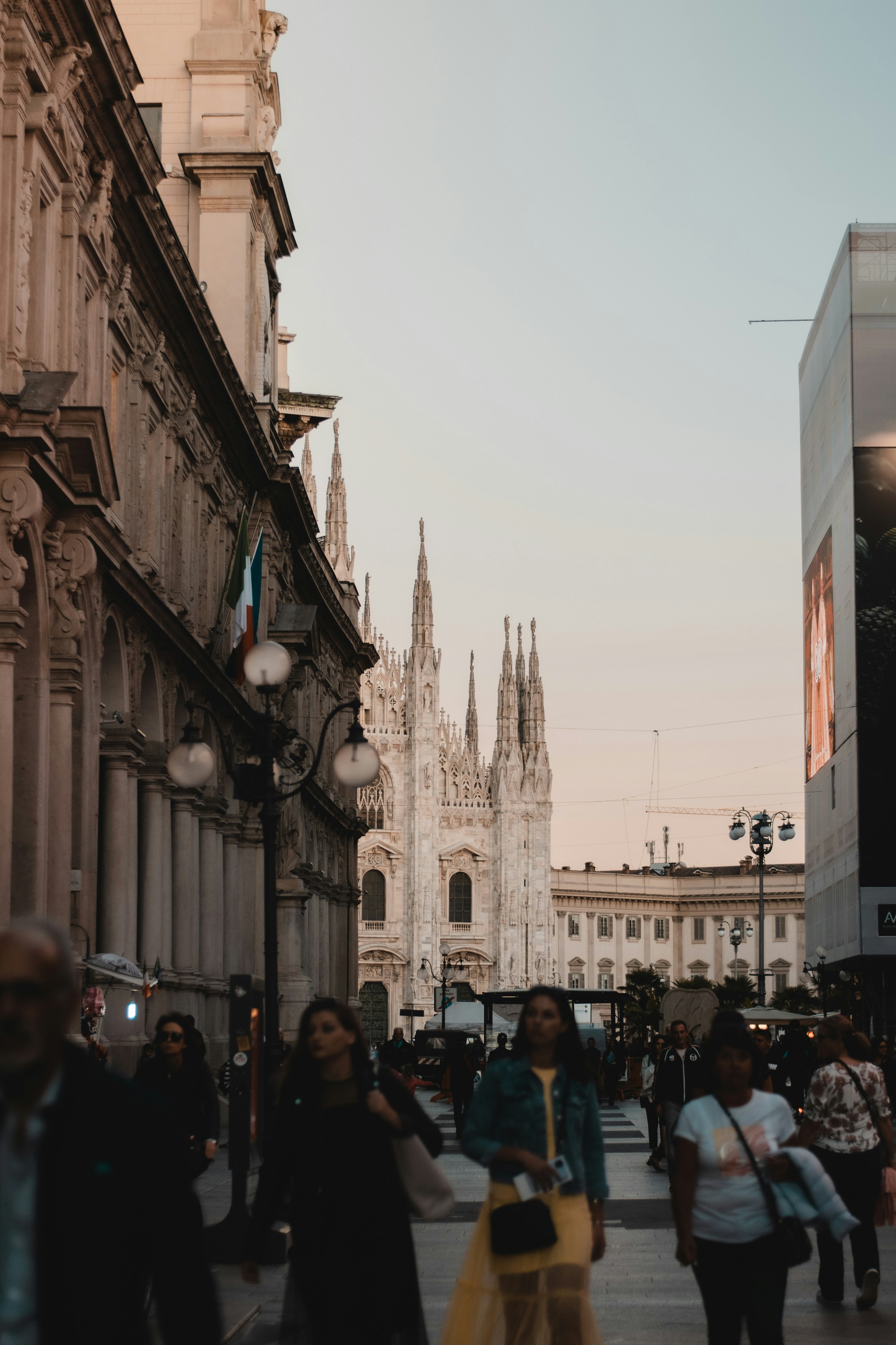 Dusk on a Milan street: the Duomo's spires rise above a busy boulevard