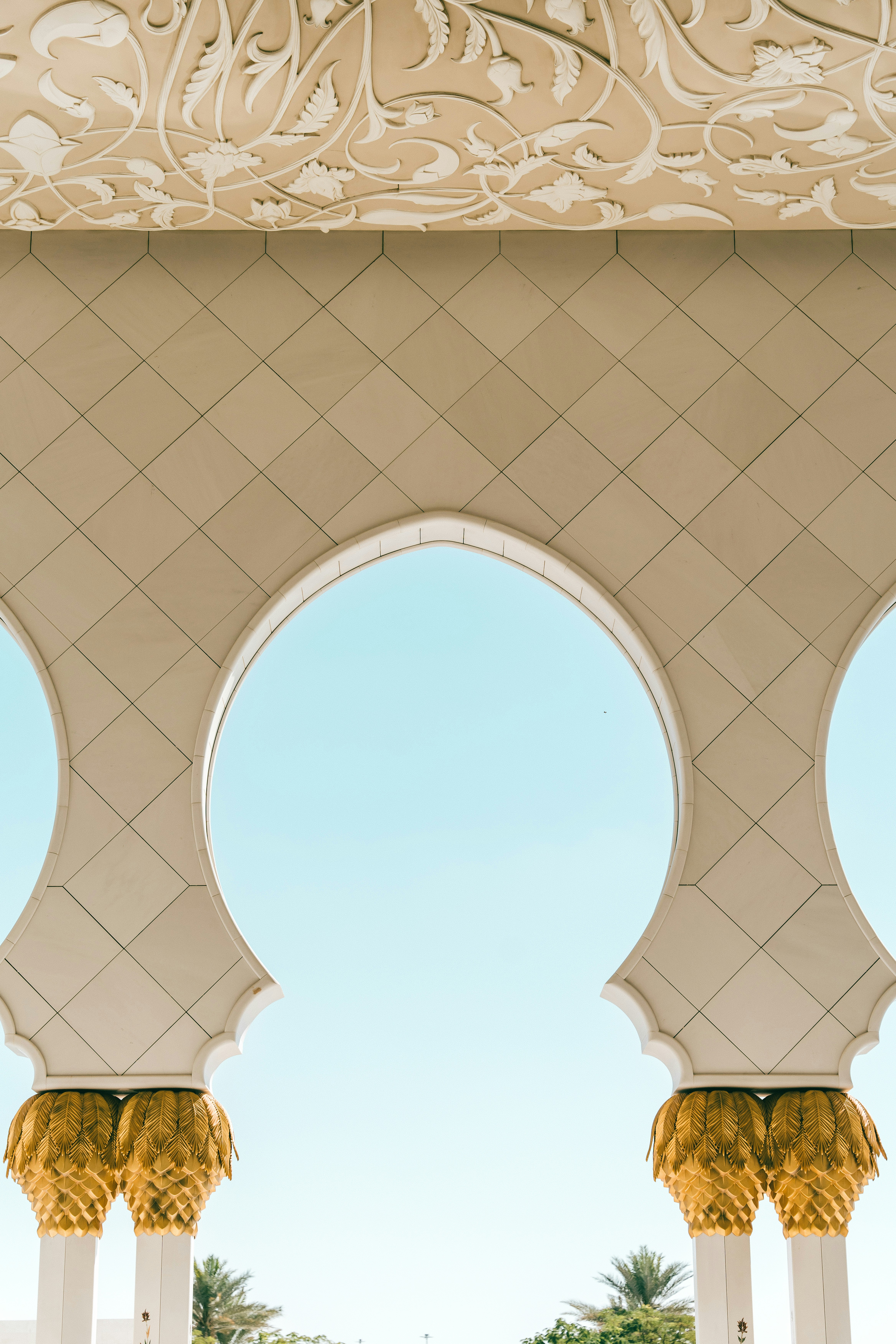 A white building with two arches and two pineapples photo – Free Abu ...