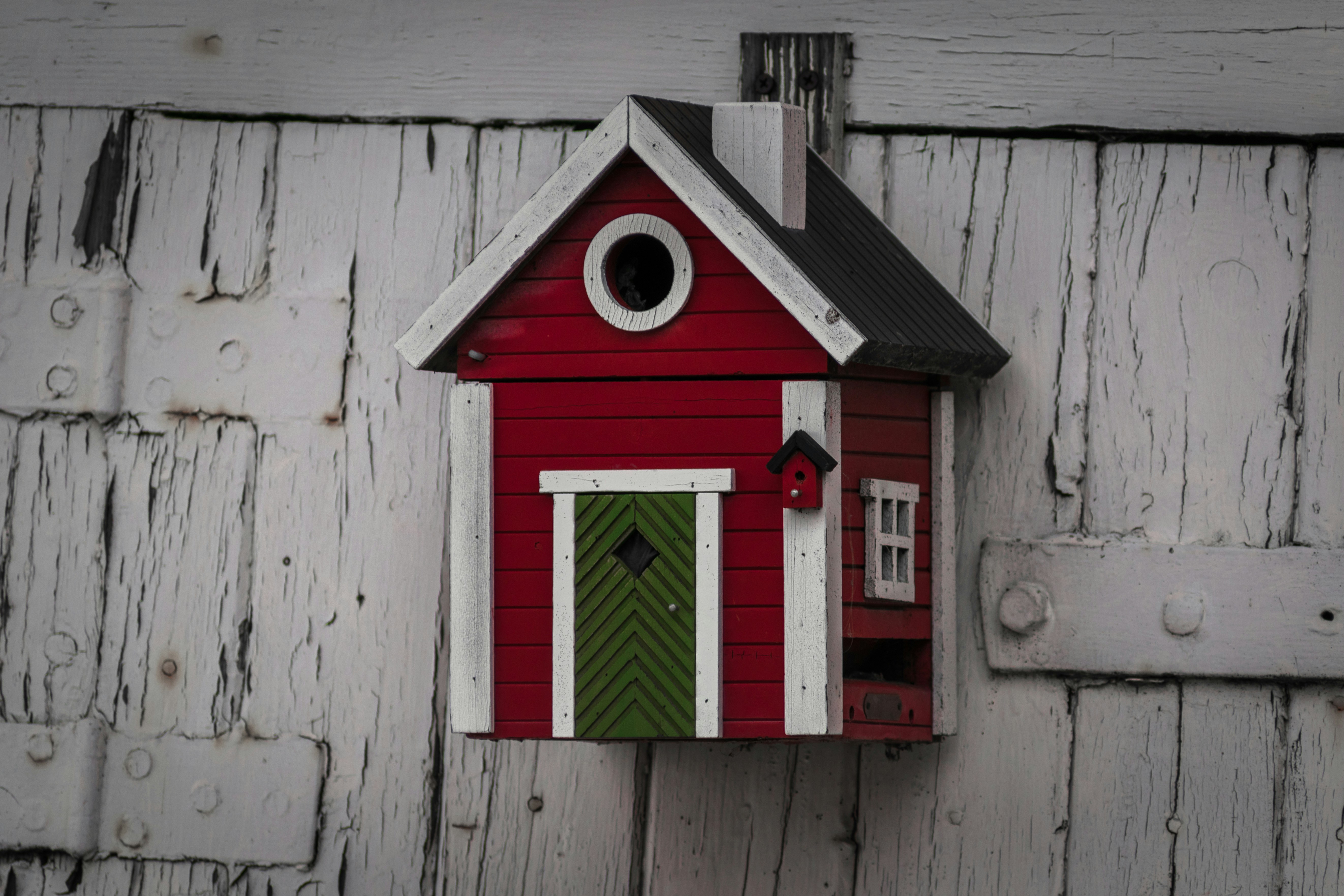 A red bird house with a green door photo – Free Small house Image on ...