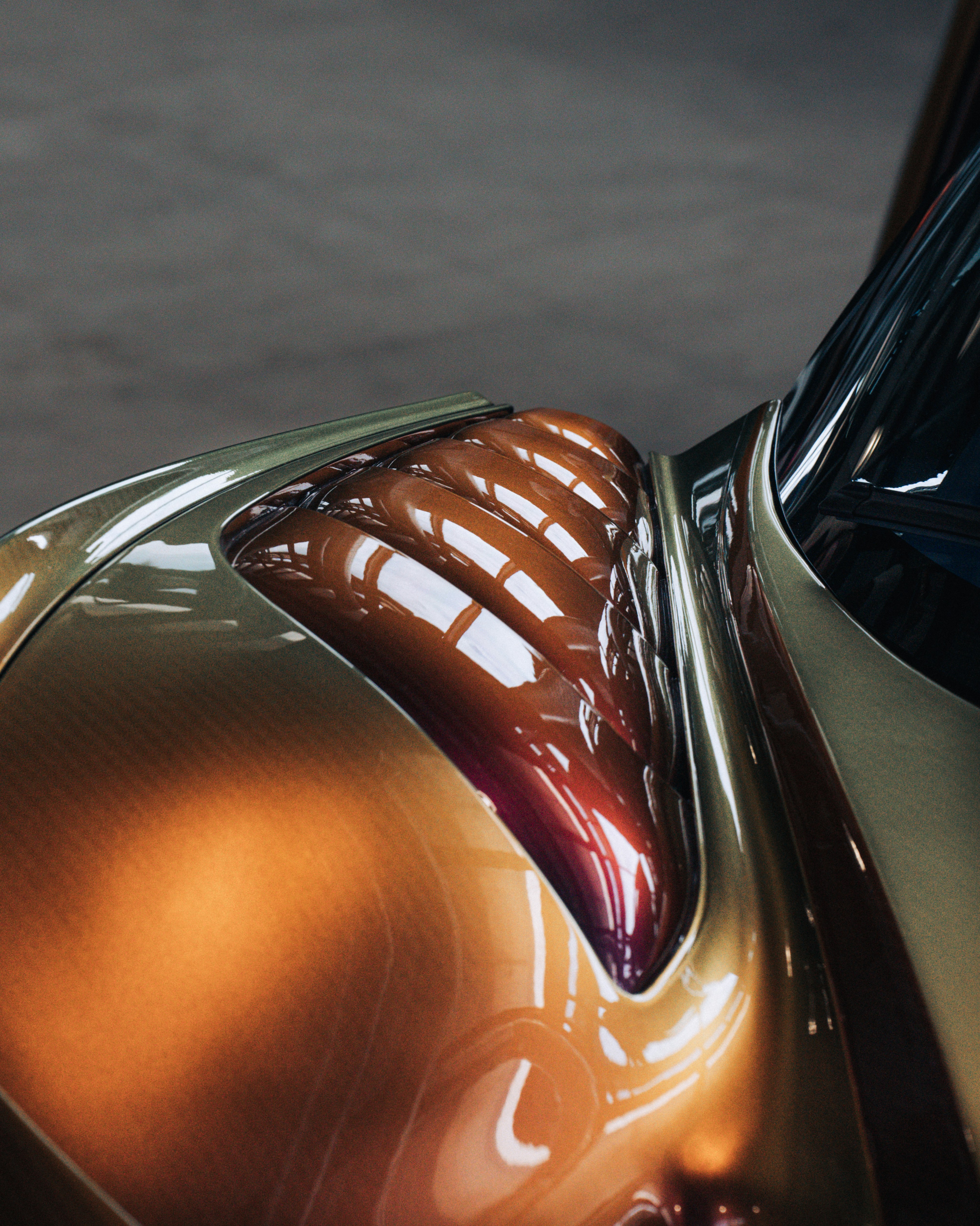 Bronze Arc: Reflections Stretch Across a Classic Car Panel