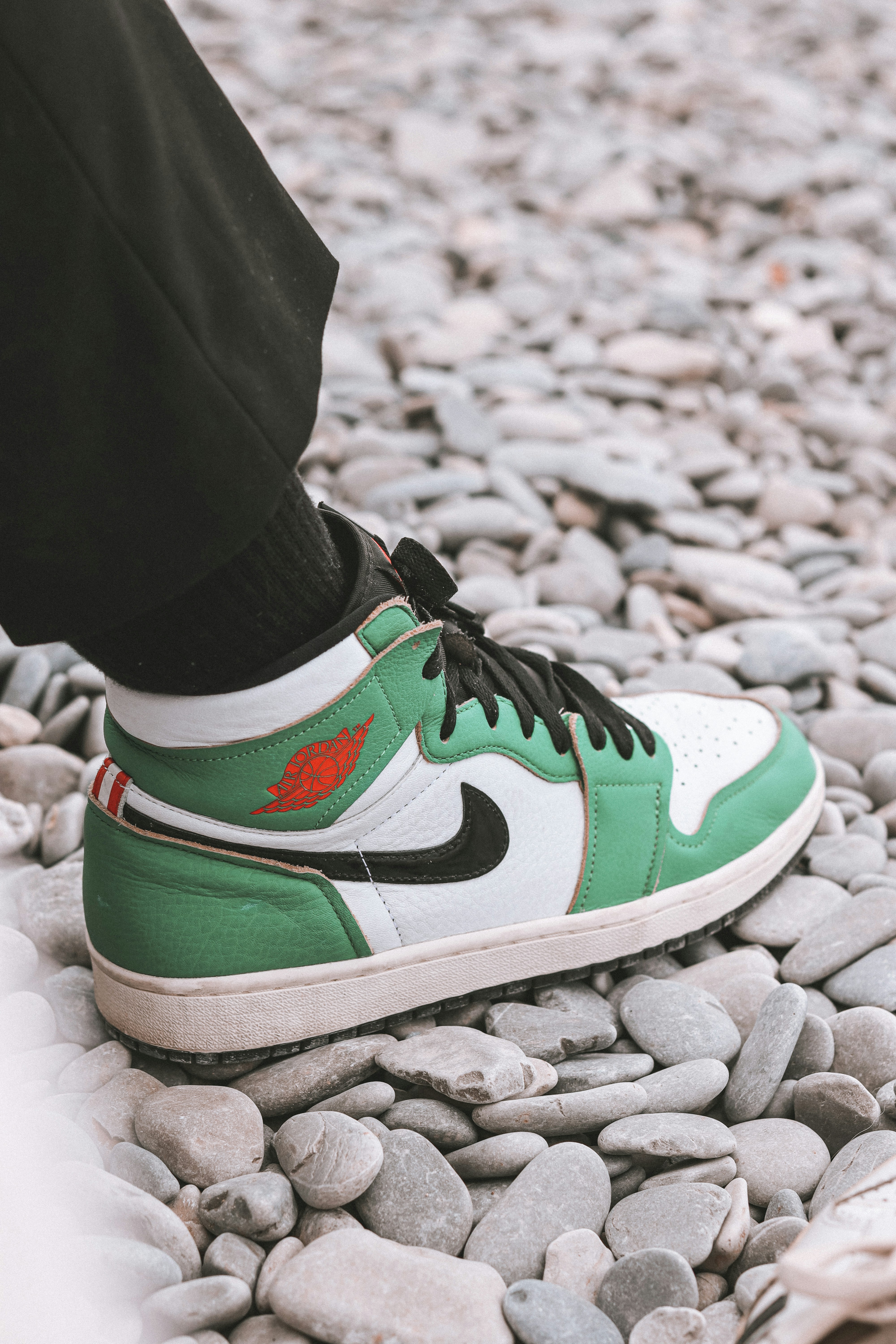 Green-White Sneaker on Pebble Ground: A Quiet Moment in Street Style