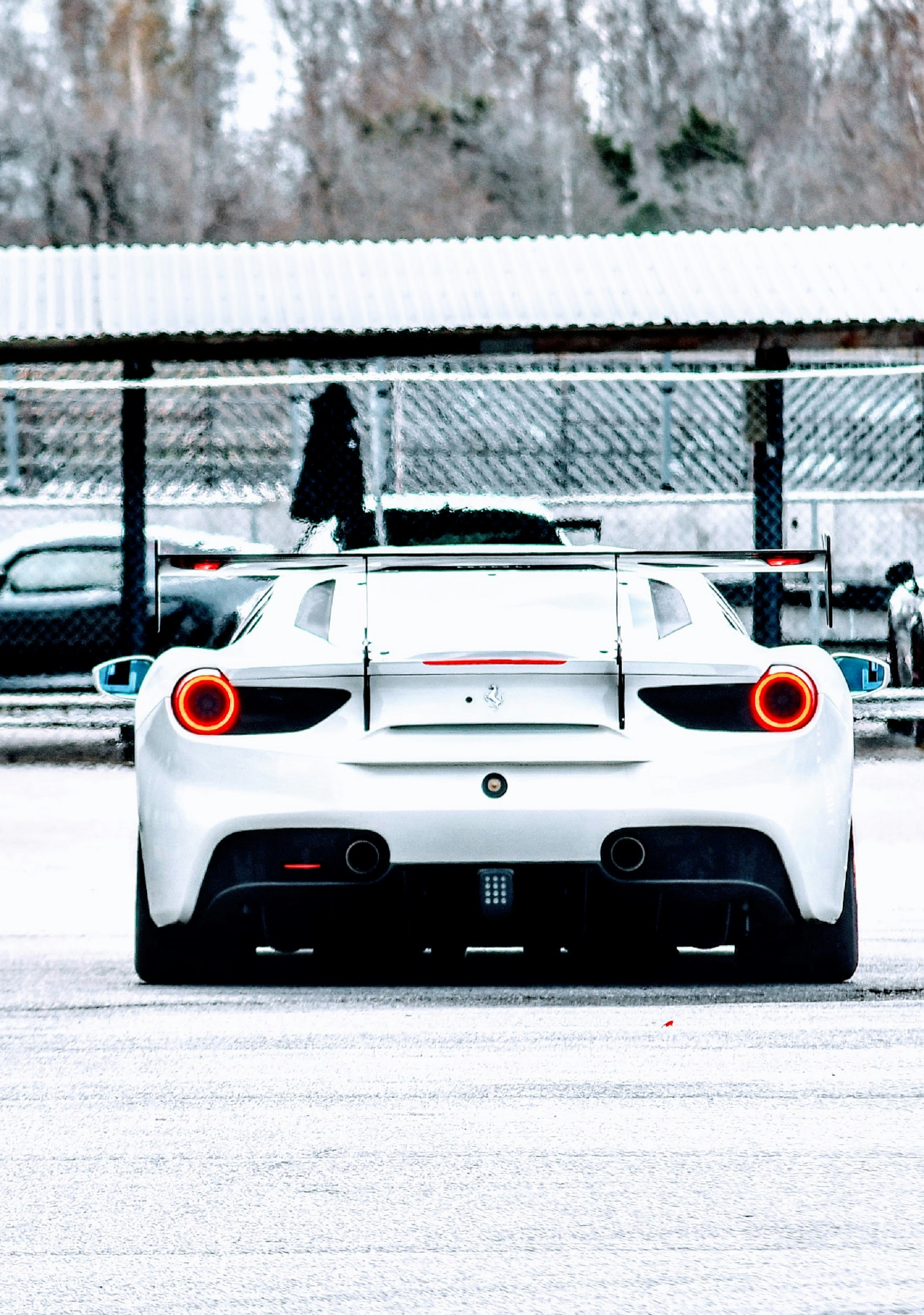 Rear-View Racer in Frost: A White Ferrari's Snowbound Presence