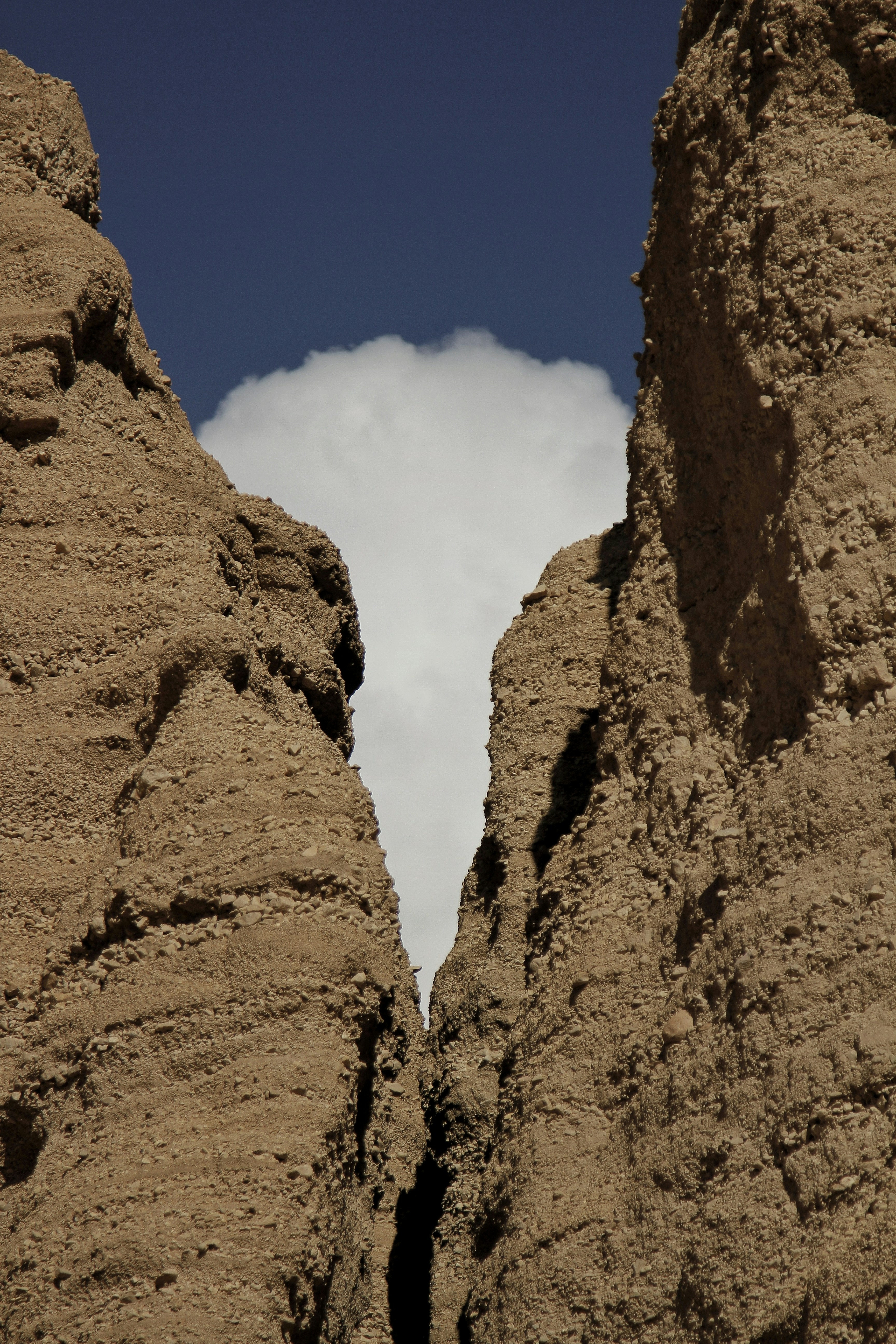 Blue Split: The Narrow Canyon Framing a Cloud