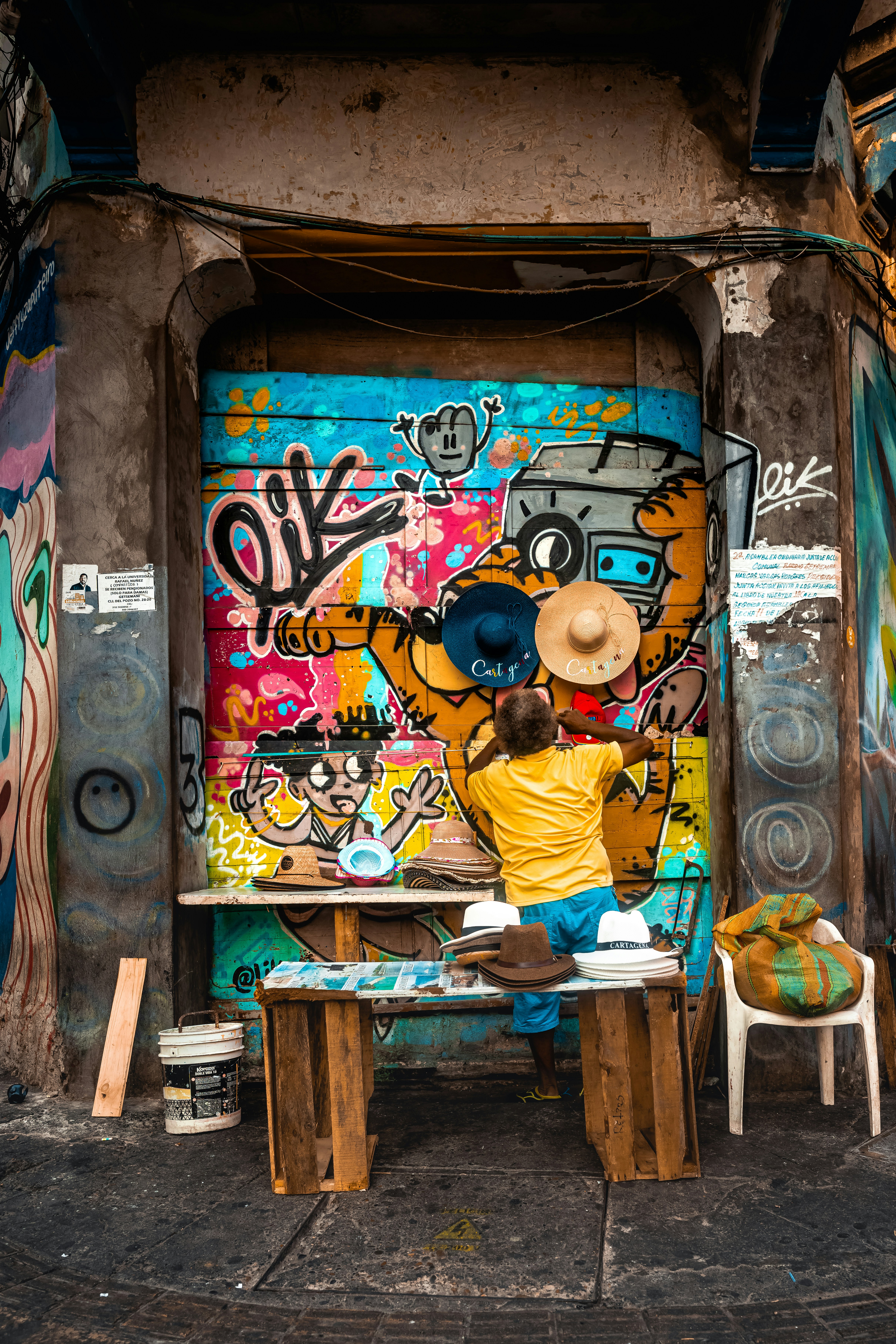 a person sitting on a bench in front of a painting