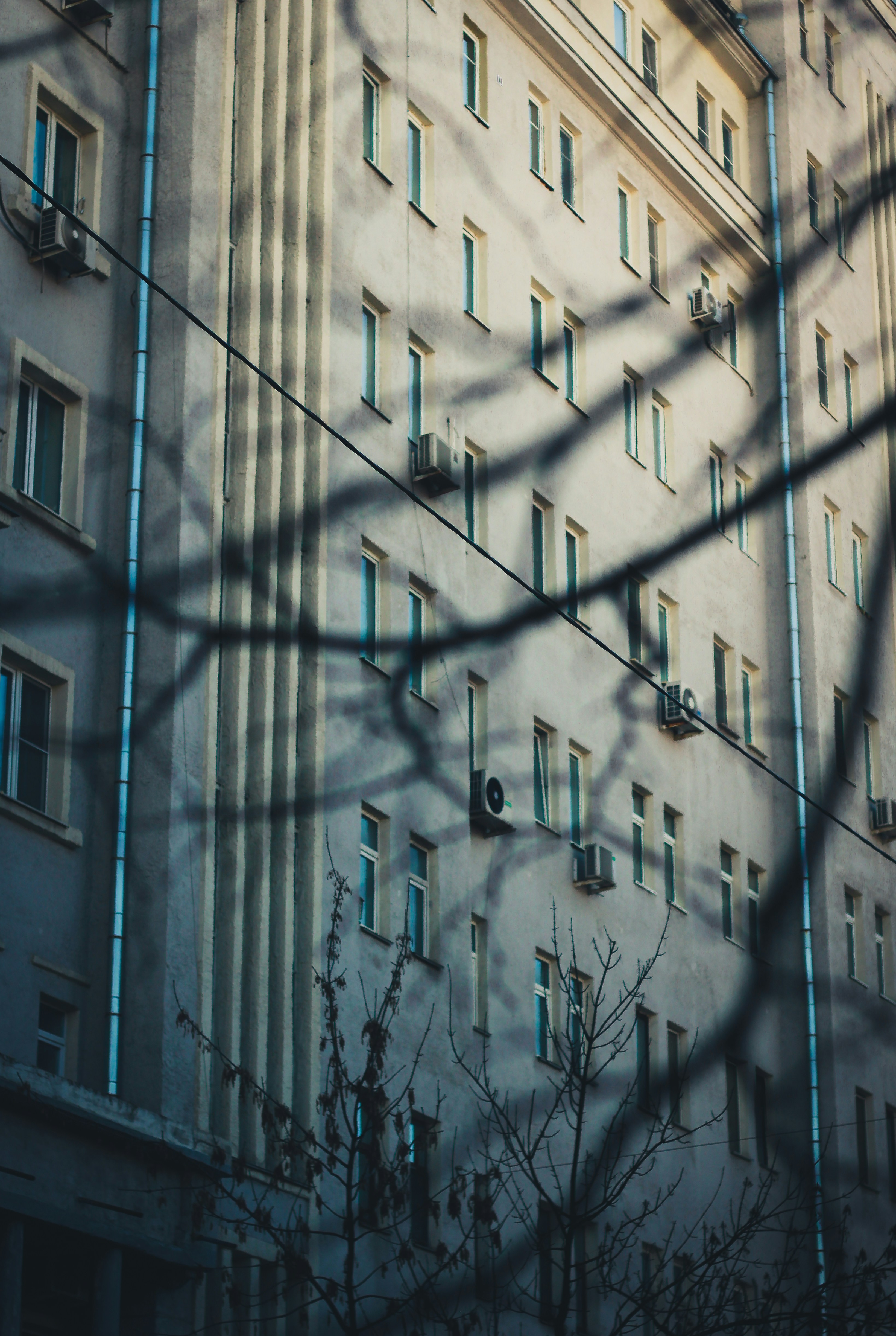 Chiaroscuro of Urban Facades: Shadows Crossing the Wall