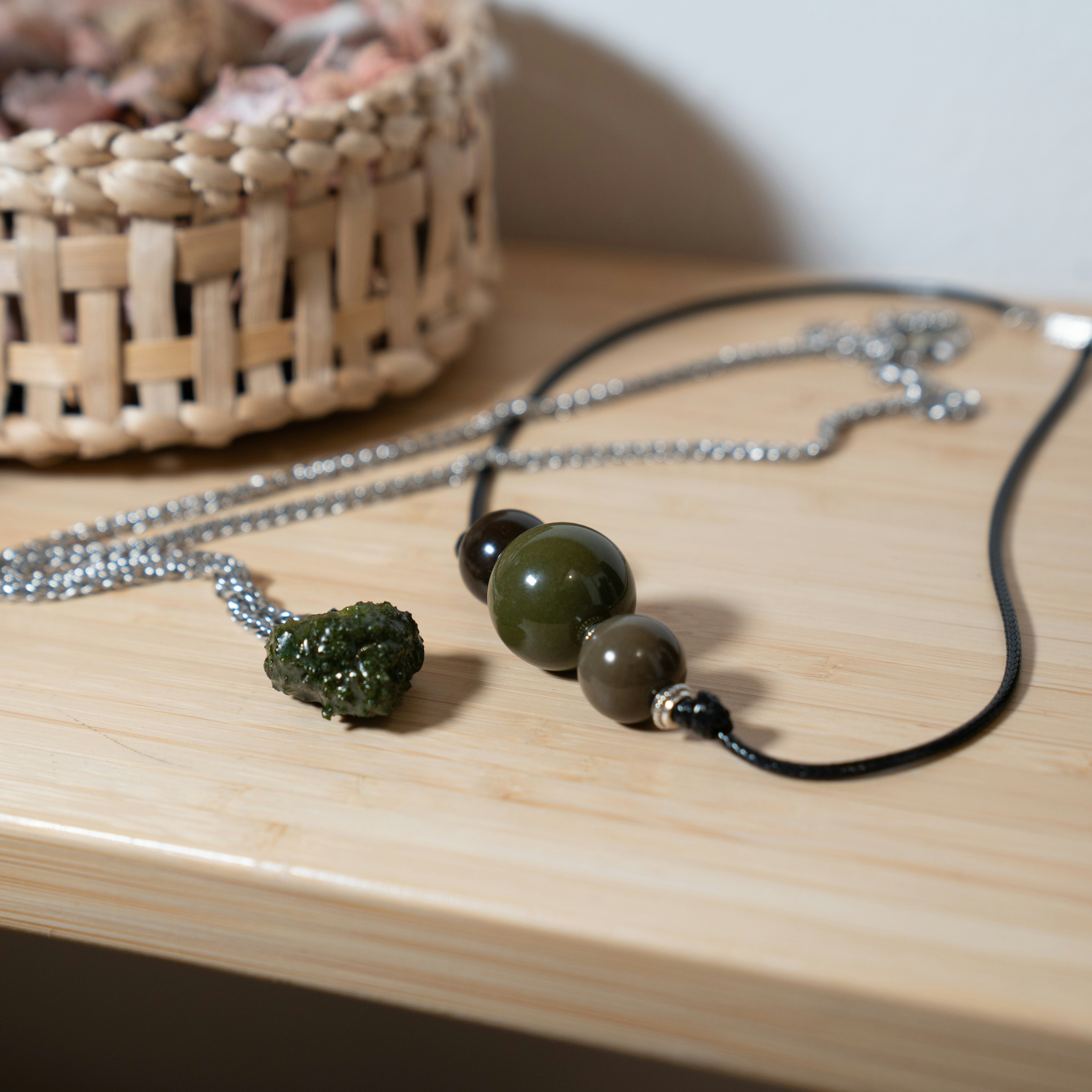 Emerald Echoes: Bead Necklace on a Sunlit Wood Surface