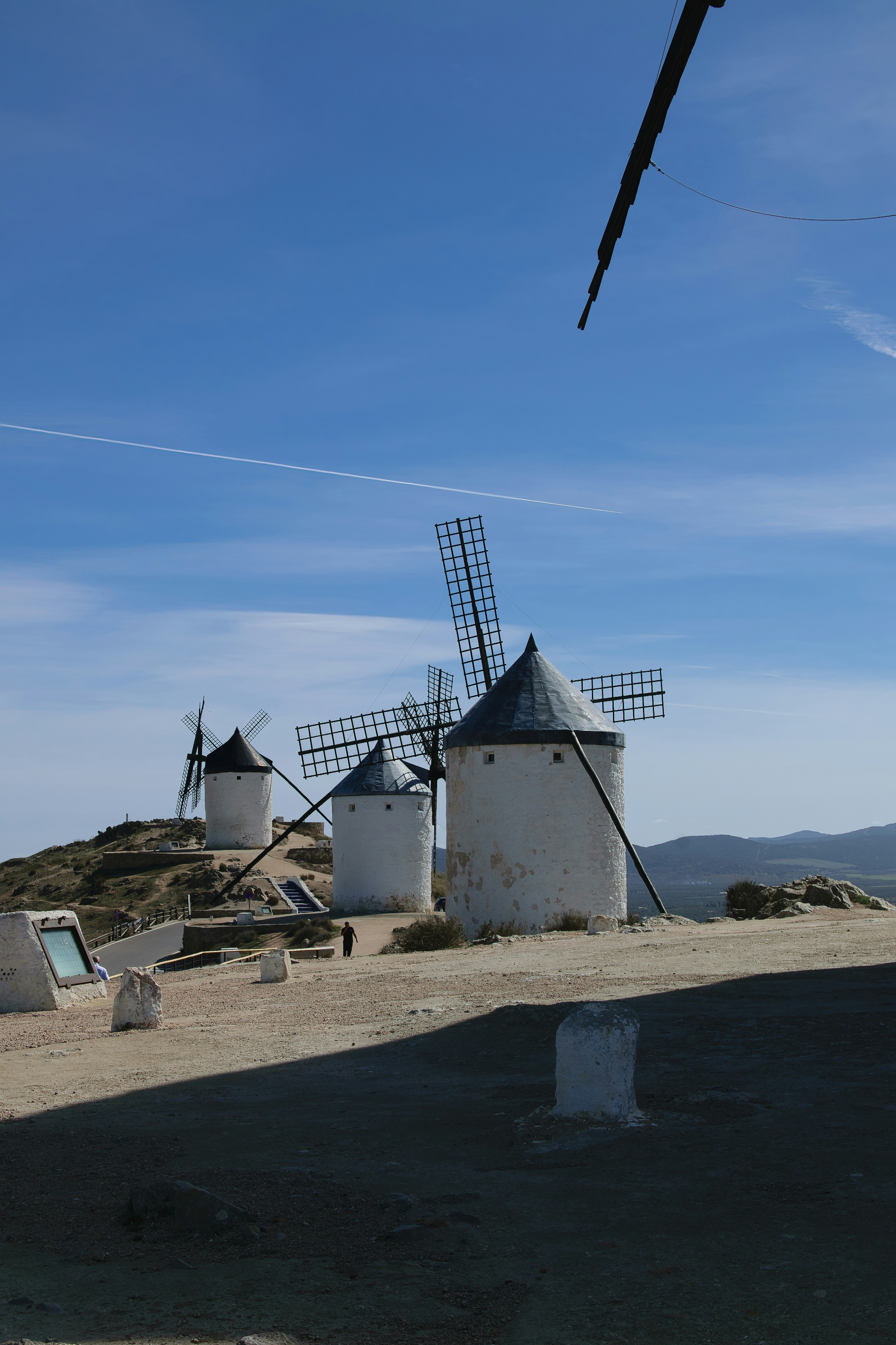 Sail Shadows: Windmills Standing Watch on a Blue Horizon