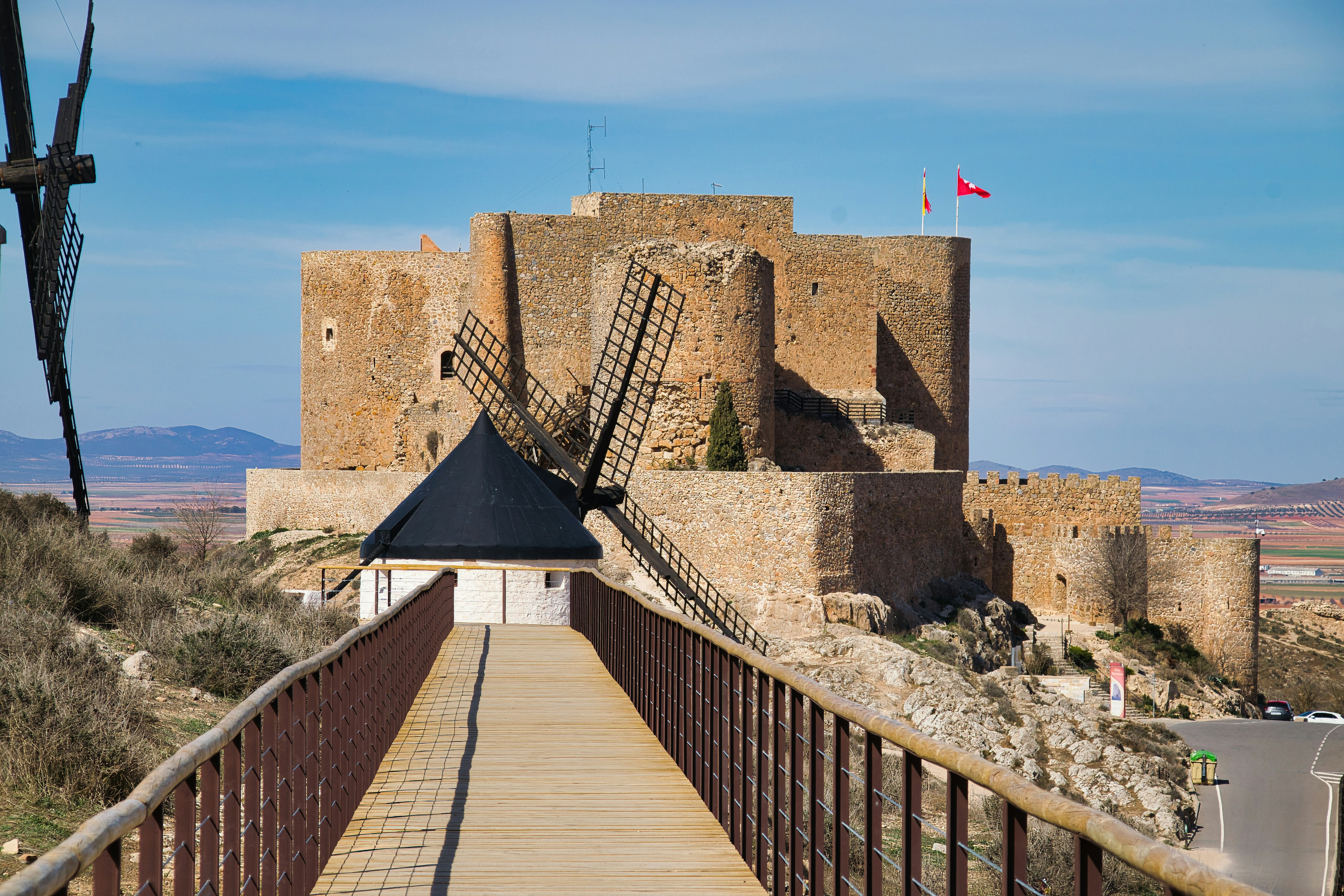 A wooden walkway leading to a castle like structure photo – Free España ...
