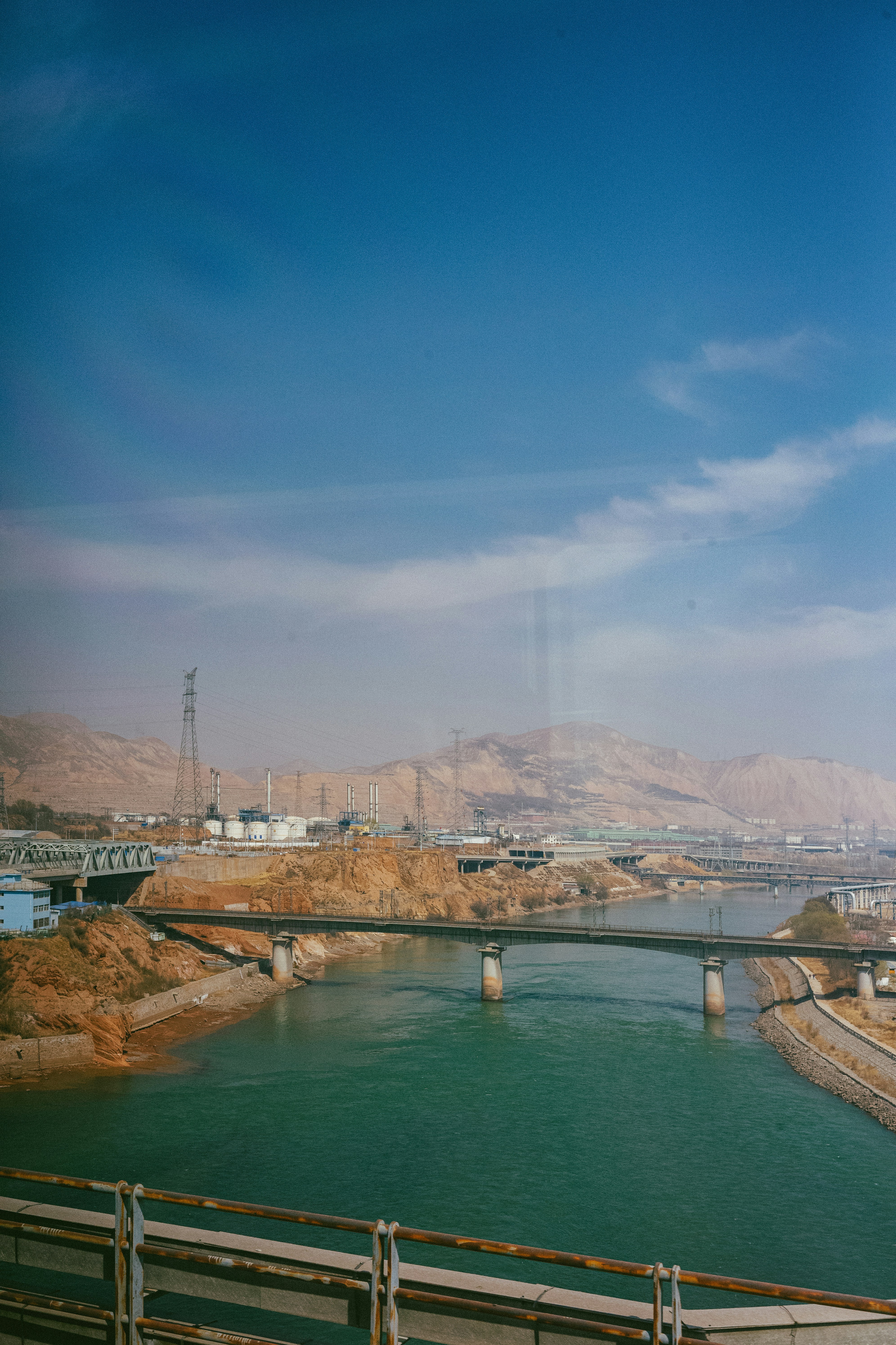 a large body of water with a bridge in the background