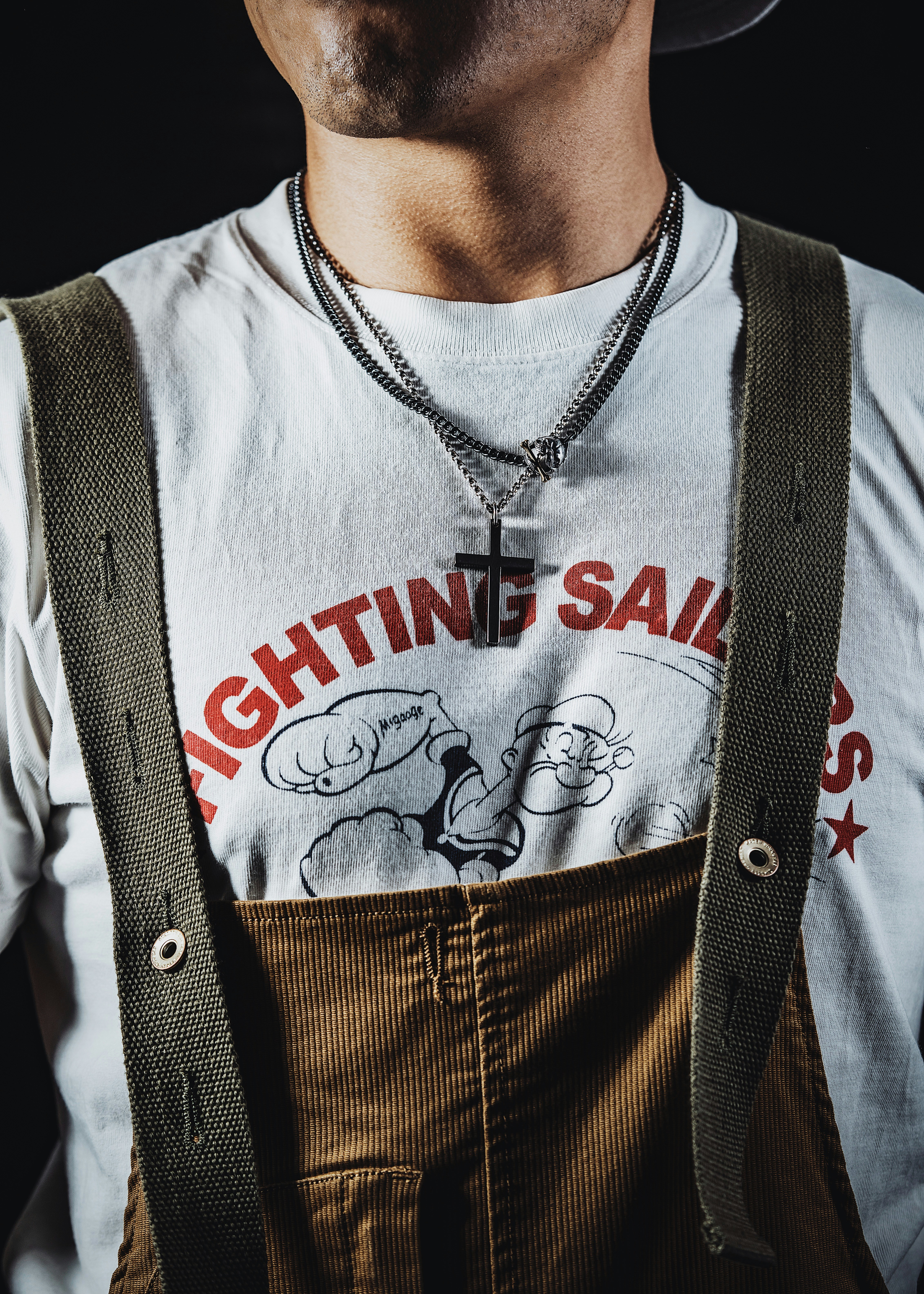 Cross Pendant Under Workwear: A Quiet Street Portrait