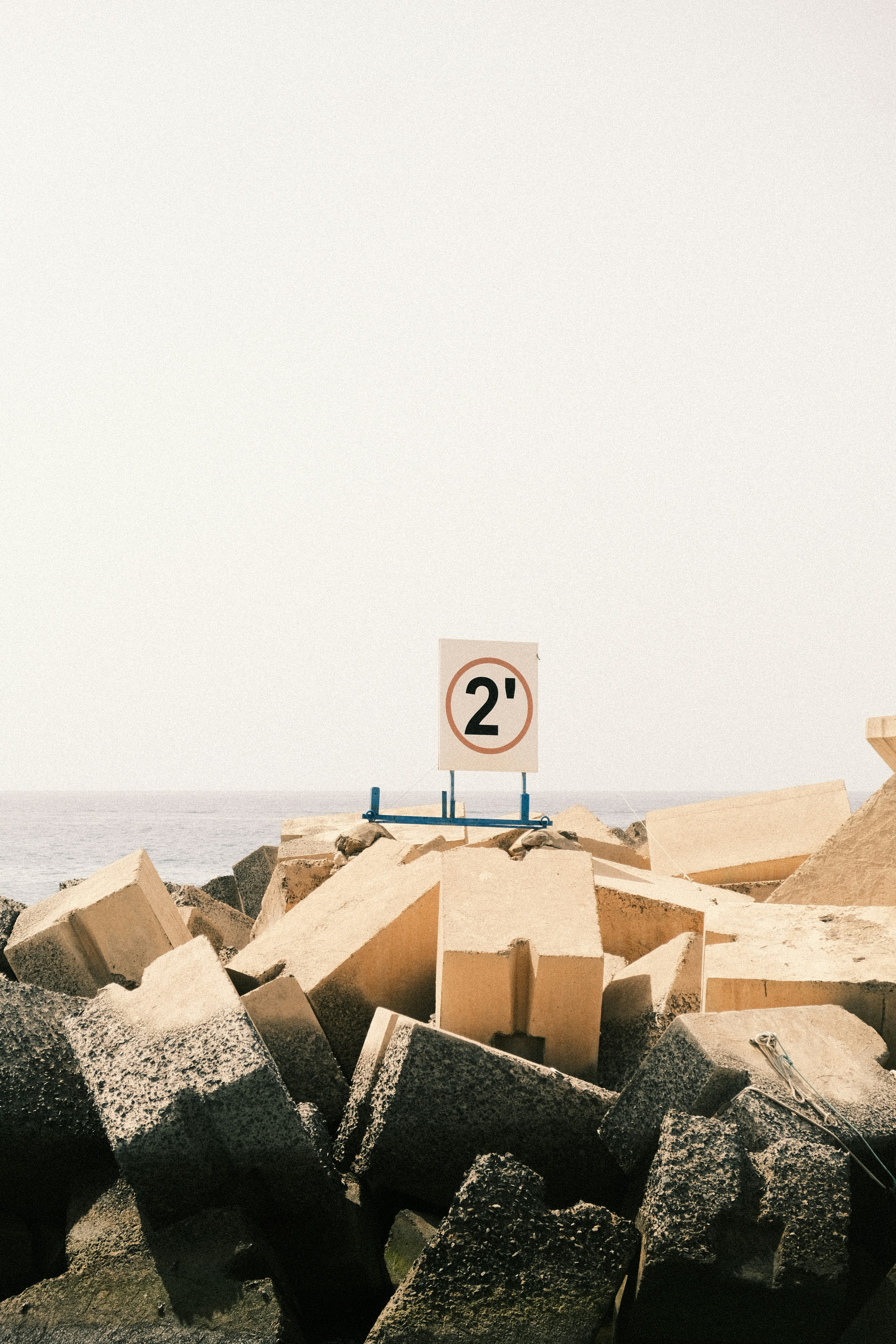 Two-Second Warning: Wave-Blocked Breakwater and Sign By the Sea