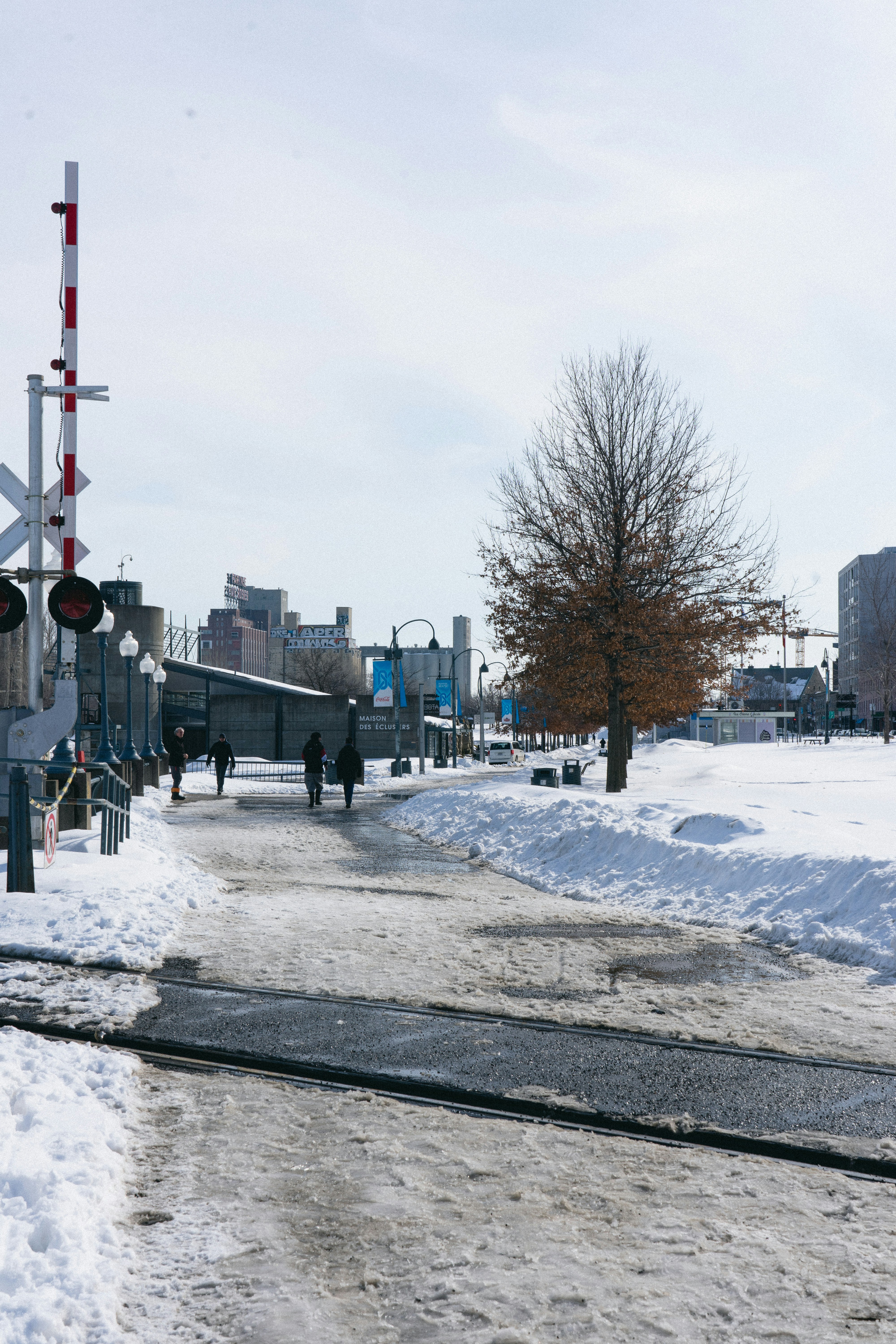 Winter Crossing: Snowy City Street by the Rails