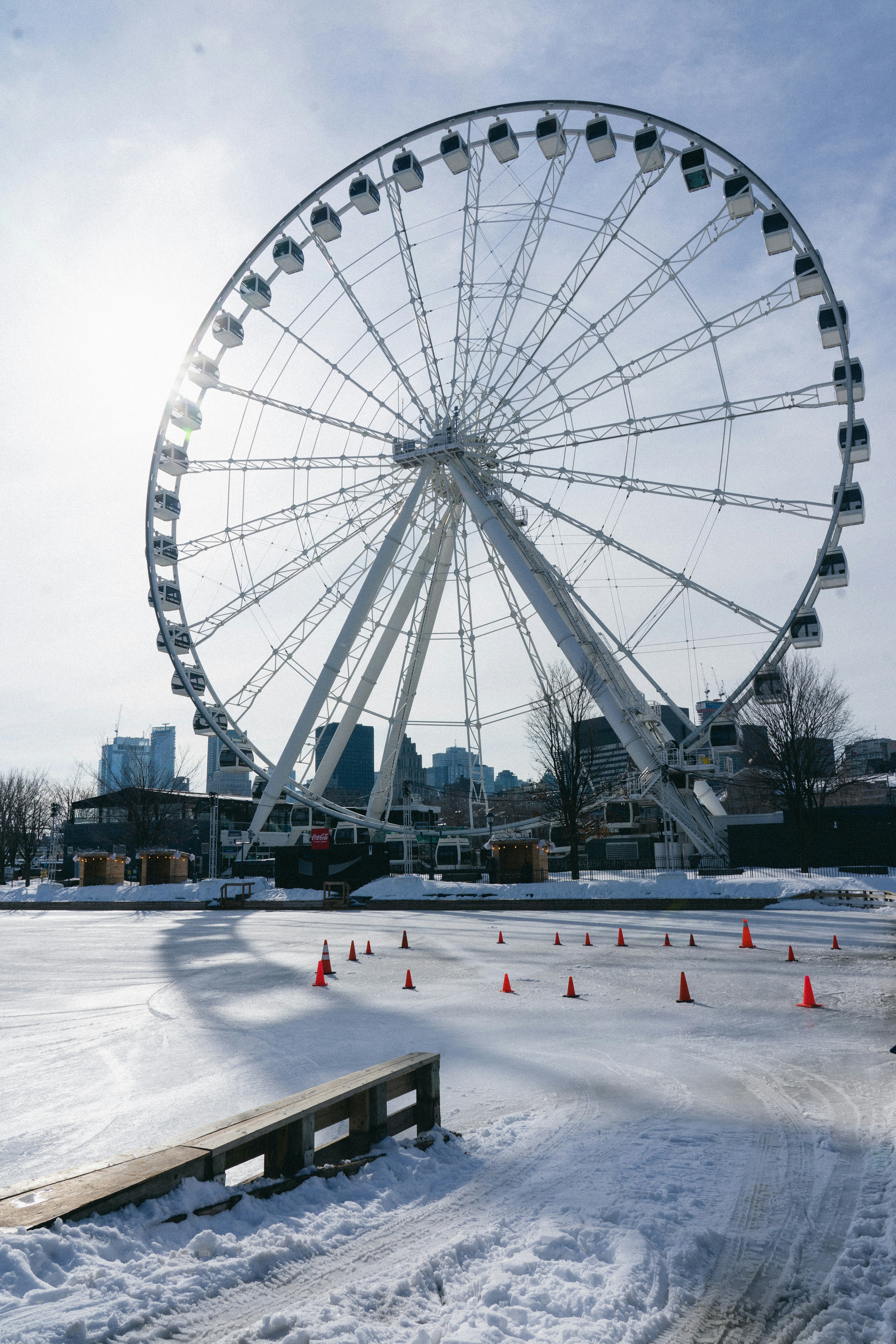 A large ferris wheel sitting in the middle of a snow covered field ...