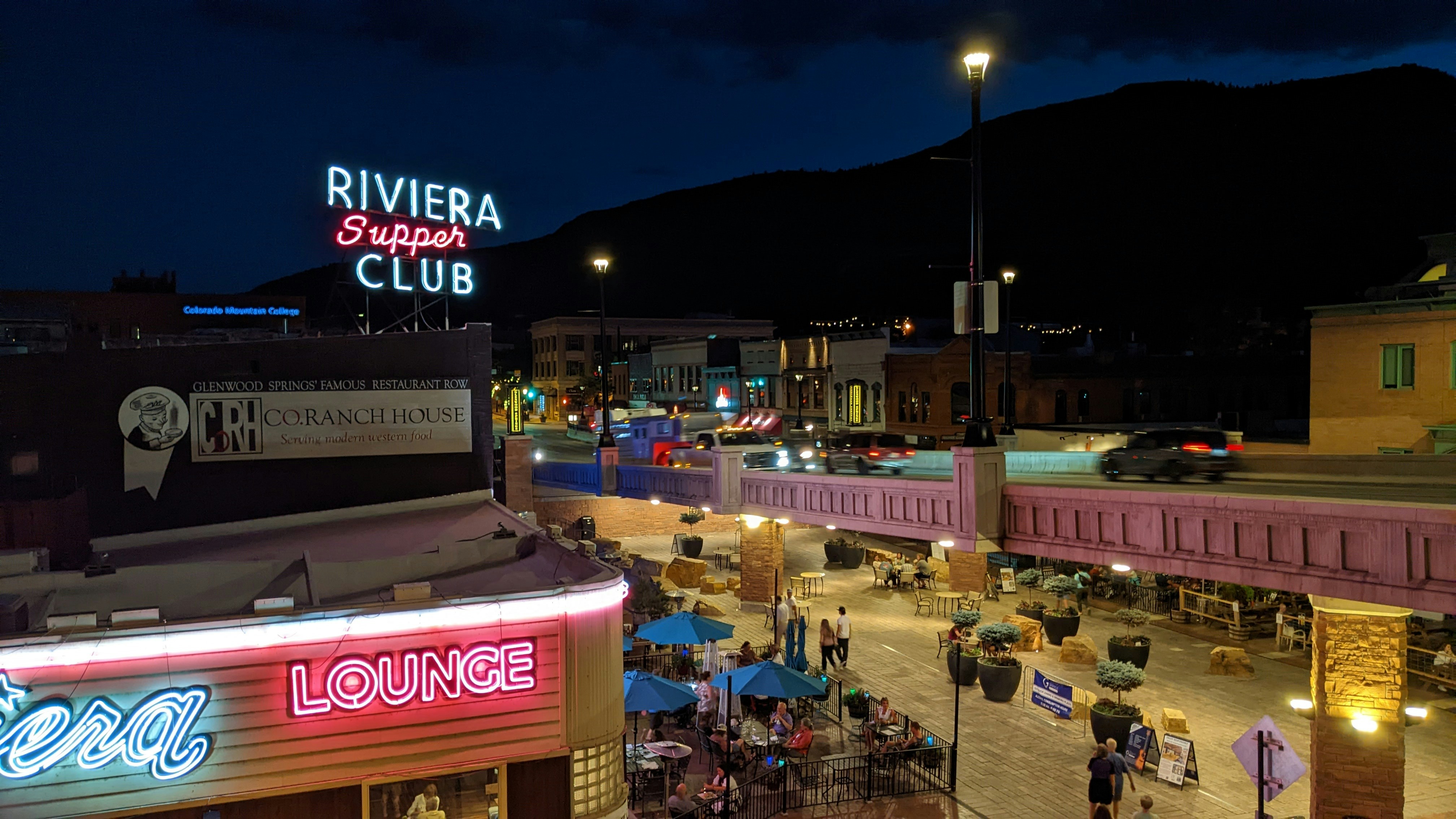 Neon Oasis by the Pier: Nightlife Beneath a City Sign