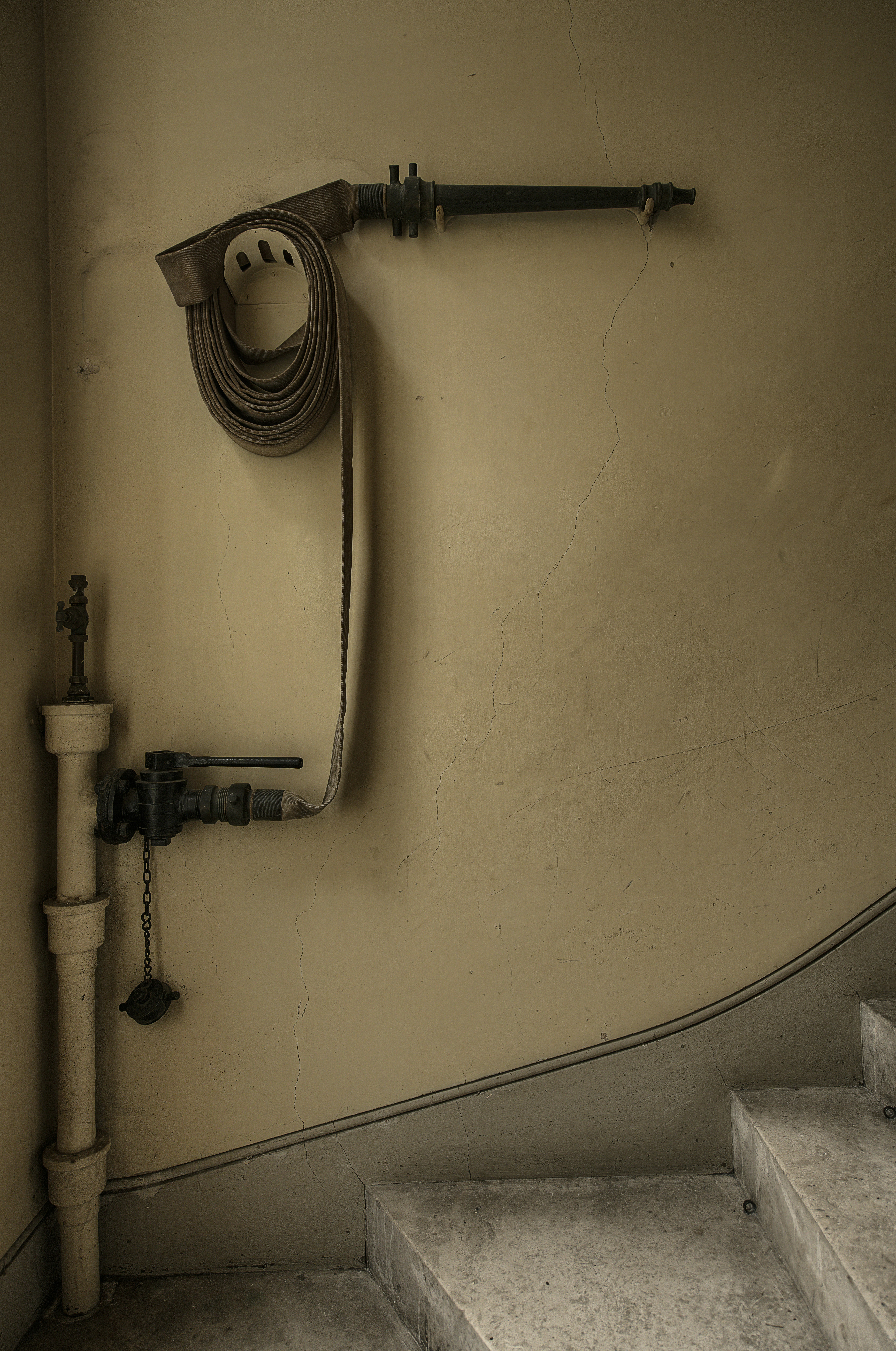A set of stairs with a hose on the wall photo – Free Stairs Image on ...