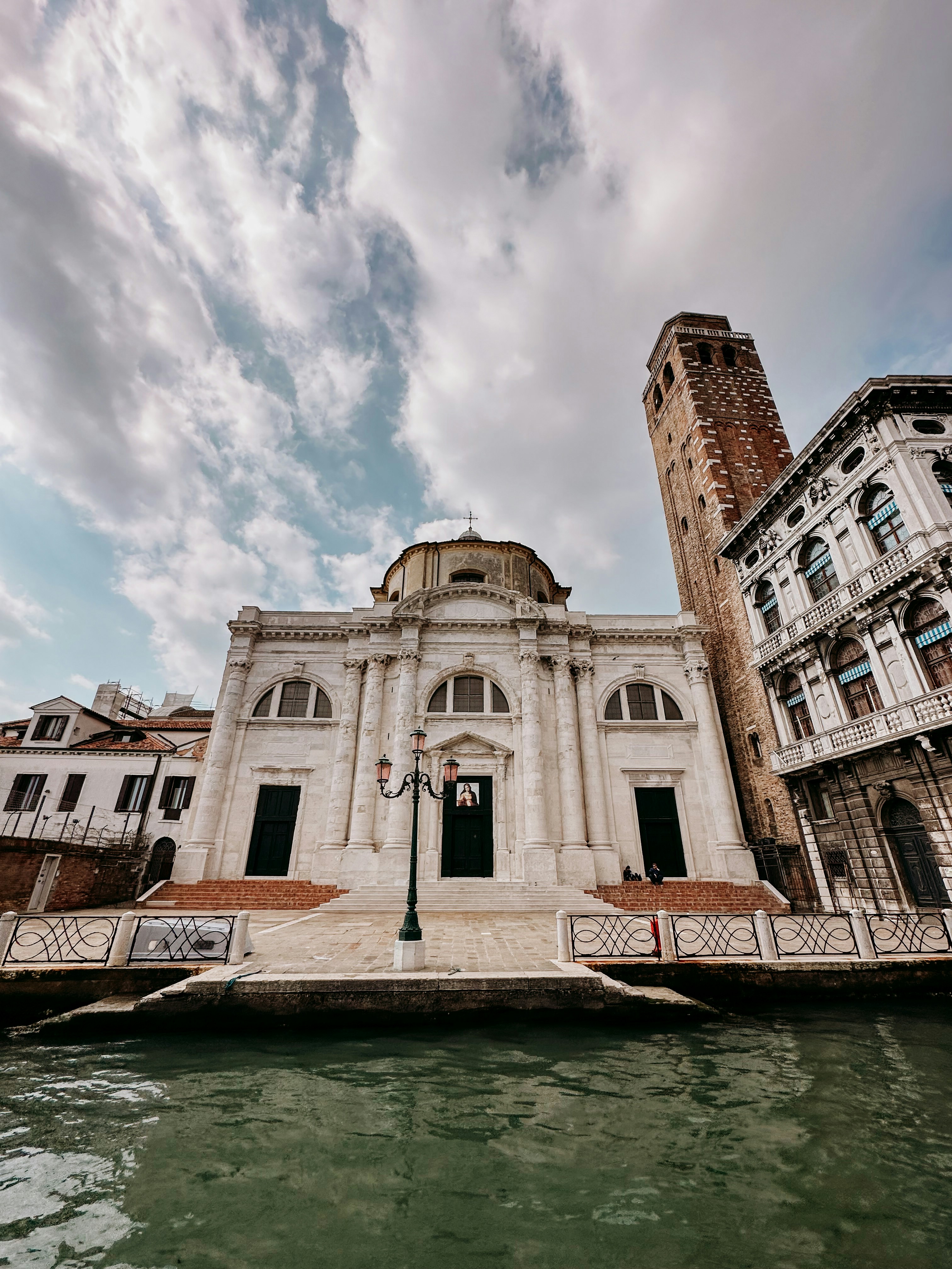 a large white building sitting next to a body of water