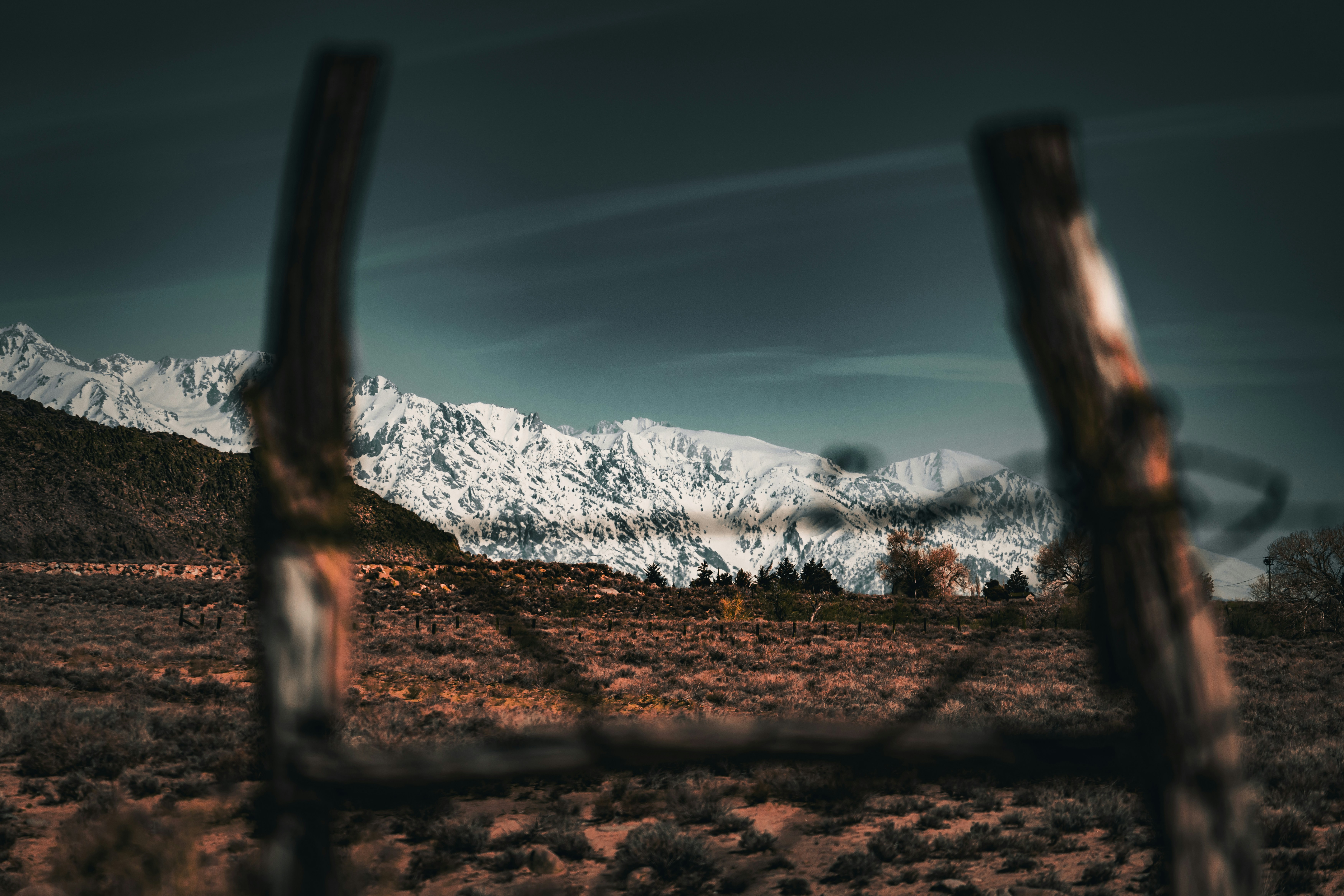 Snowbound Ridge Framed by Weathered Rails