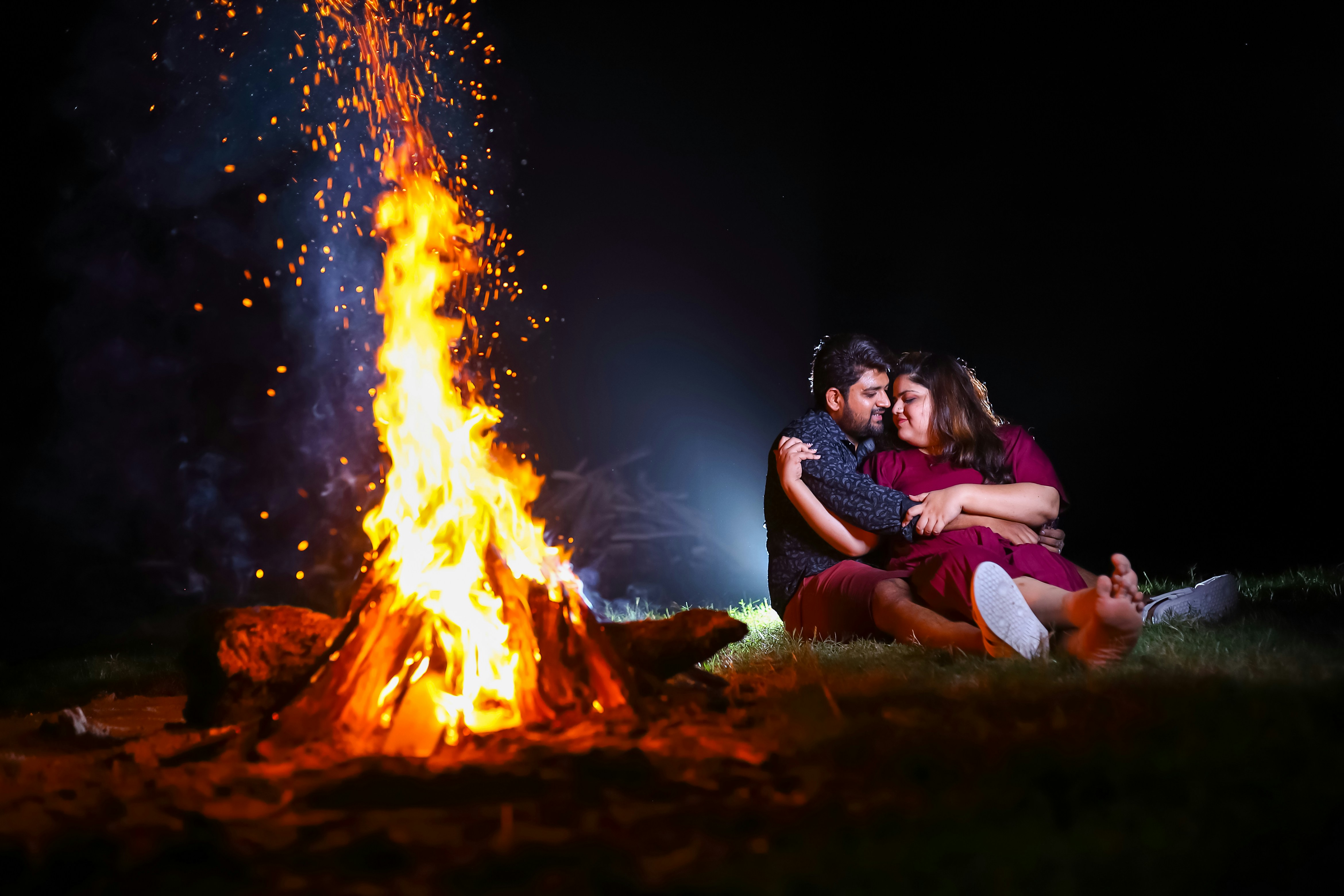 Two people sitting next to a bonfire at night photo – Free Woman Image ...