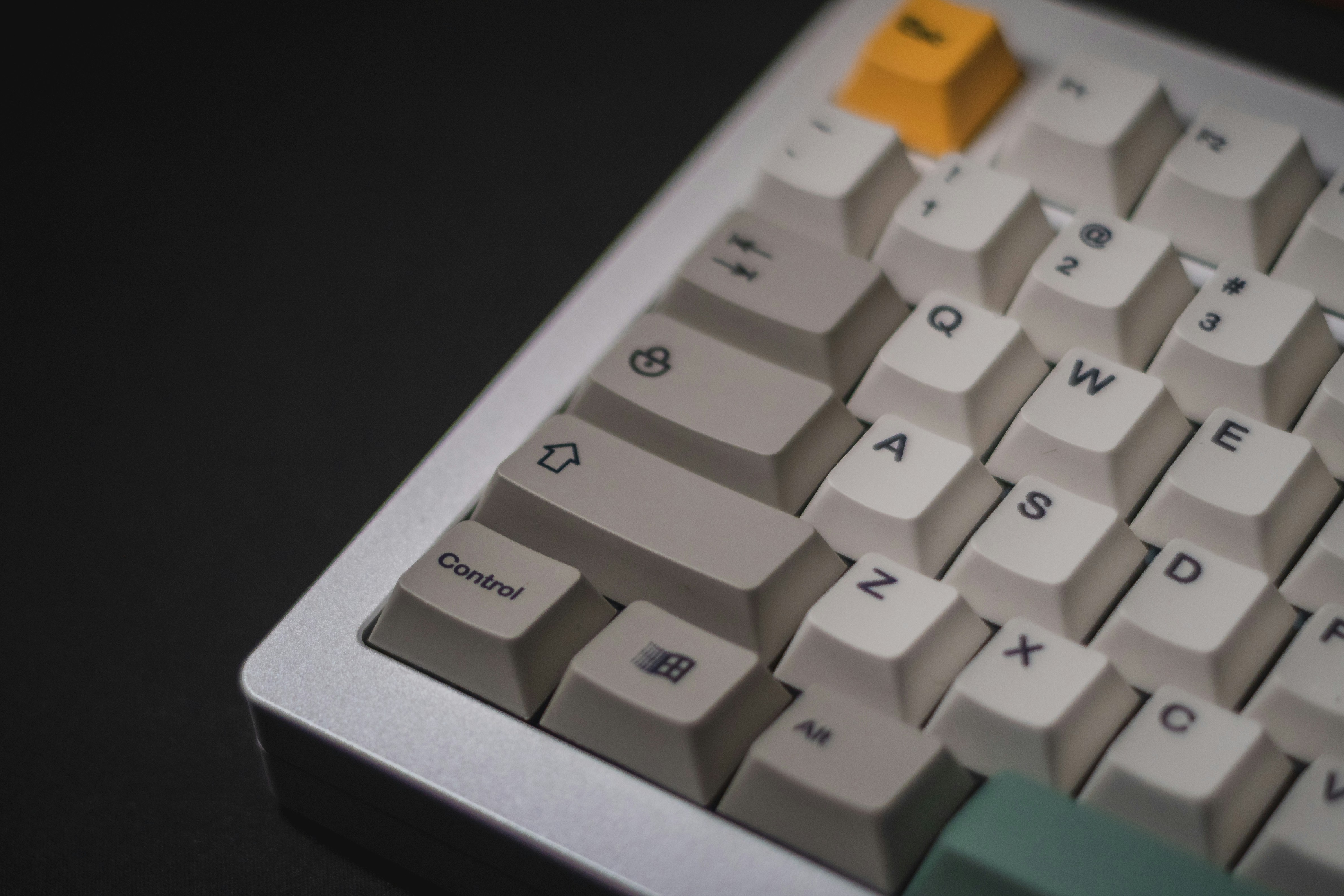 A close up of a white keyboard with yellow keys photo – Free Keyboard ...
