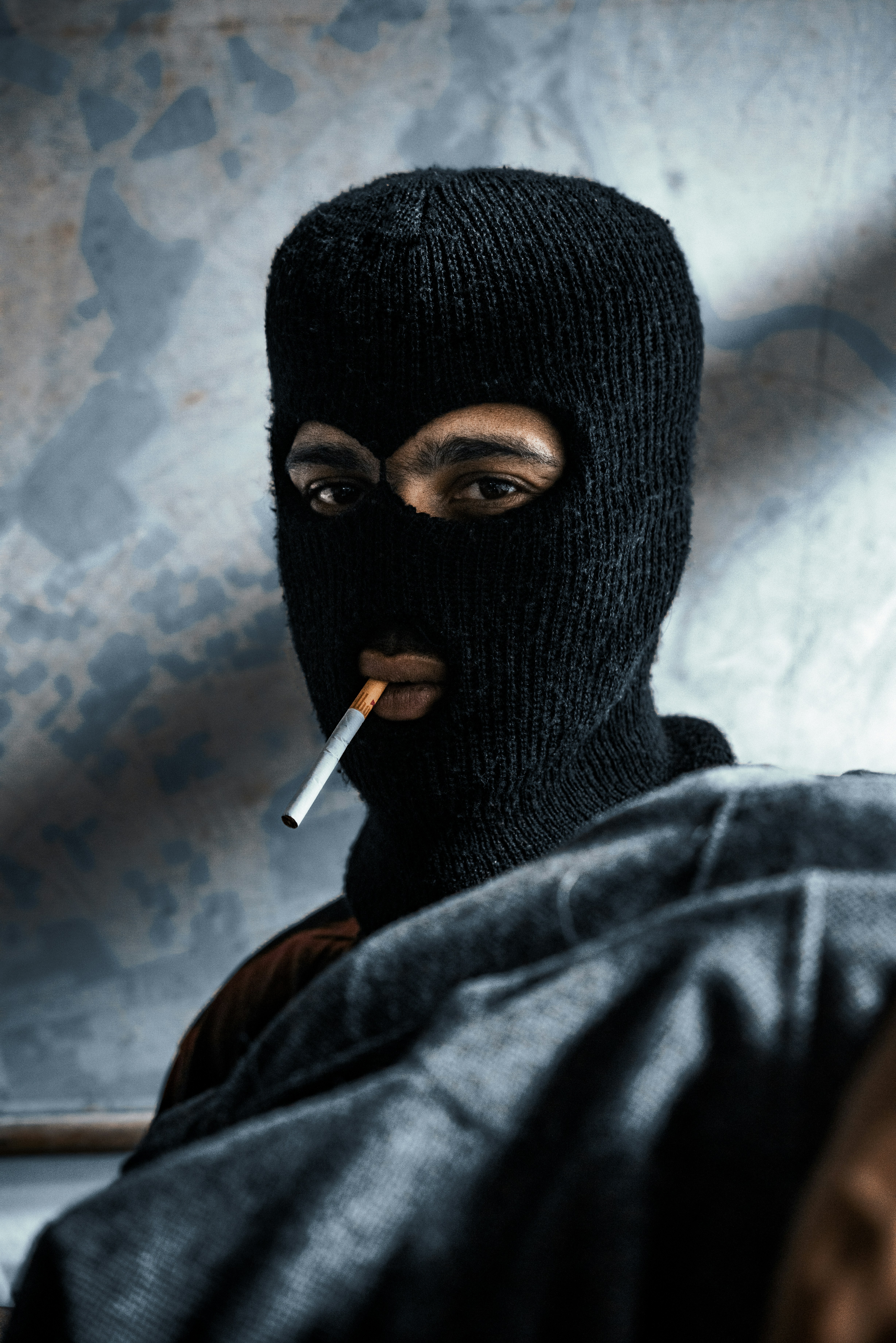 A man in a black mask smoking a cigarette photo – Free African model ...