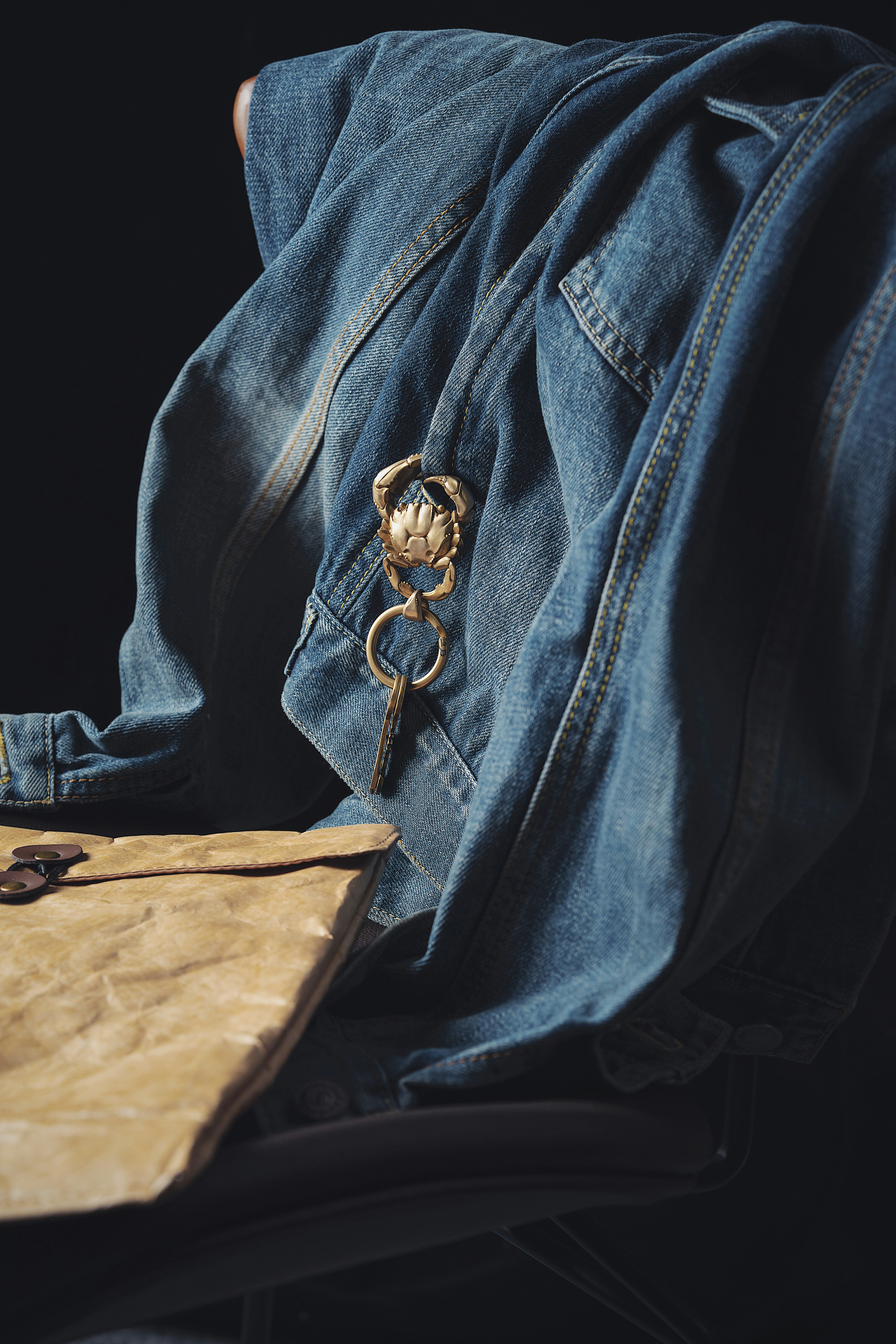 Denim Memory: A Leather Wallet Resting on a Curved Jacket Quilt