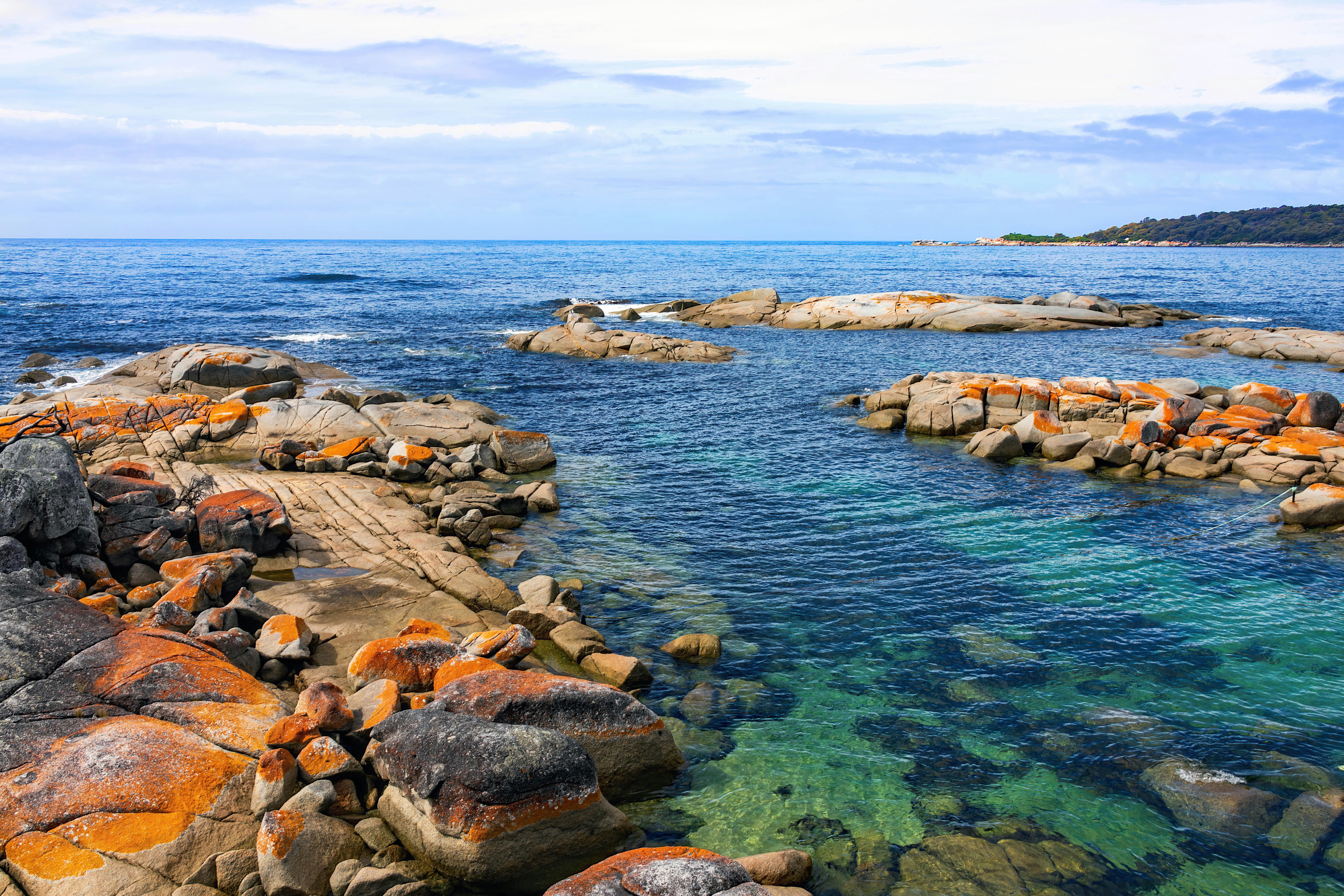 A body of water surrounded by rocks and water photo – Free Australia ...
