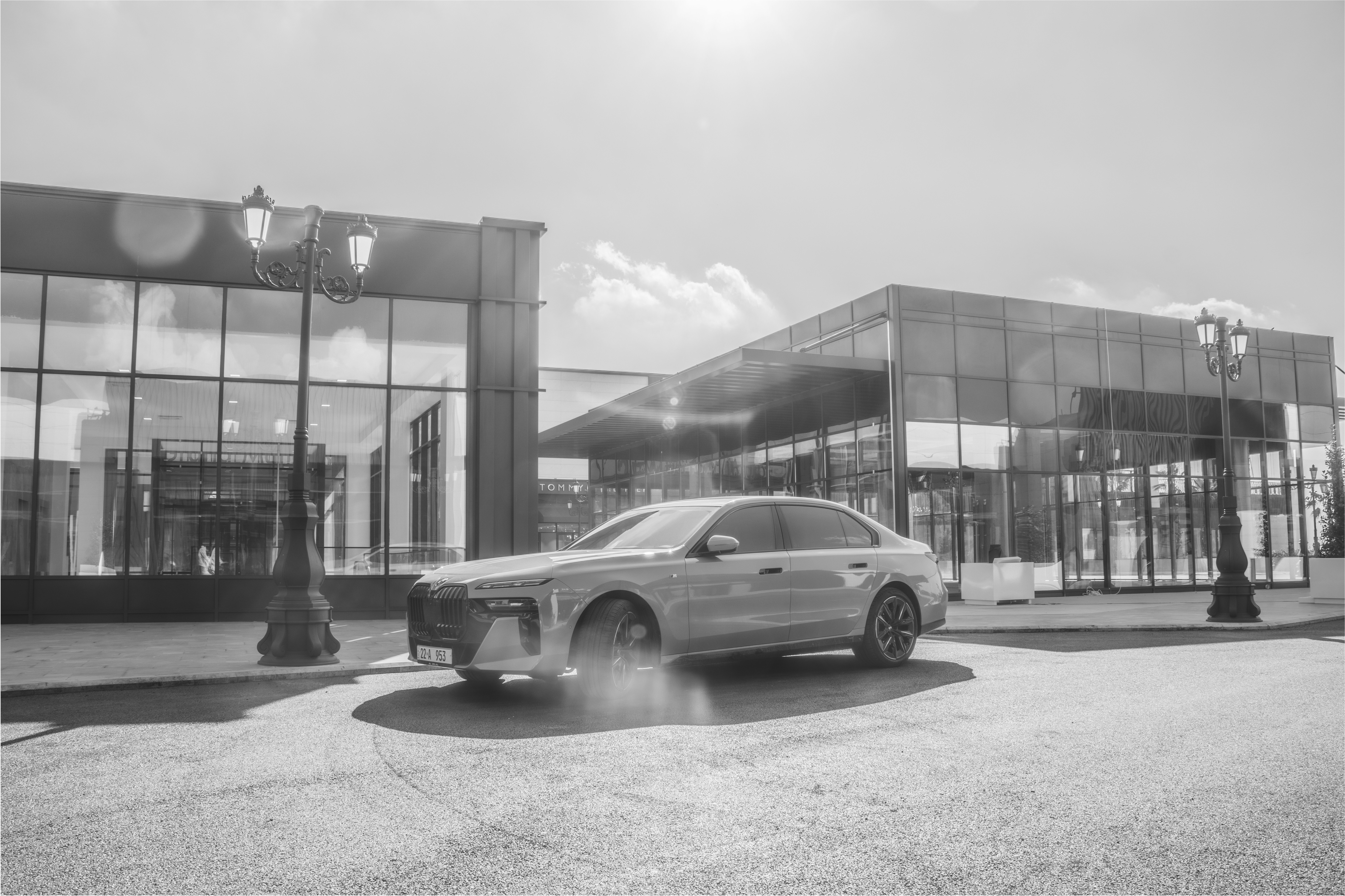 a silver car is parked in front of a building