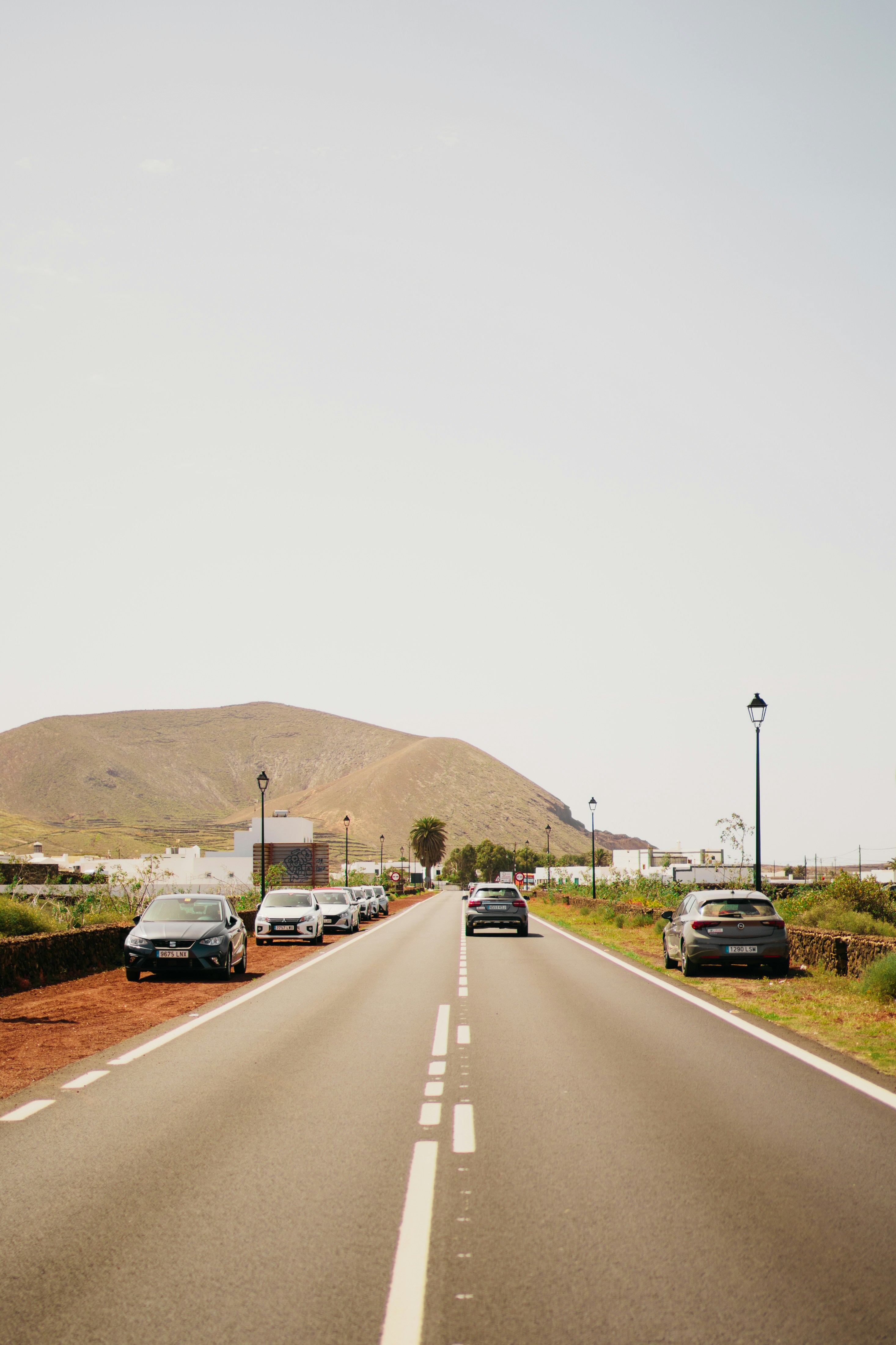 A street with cars parked on the side of it photo – Free Lanzarote ...