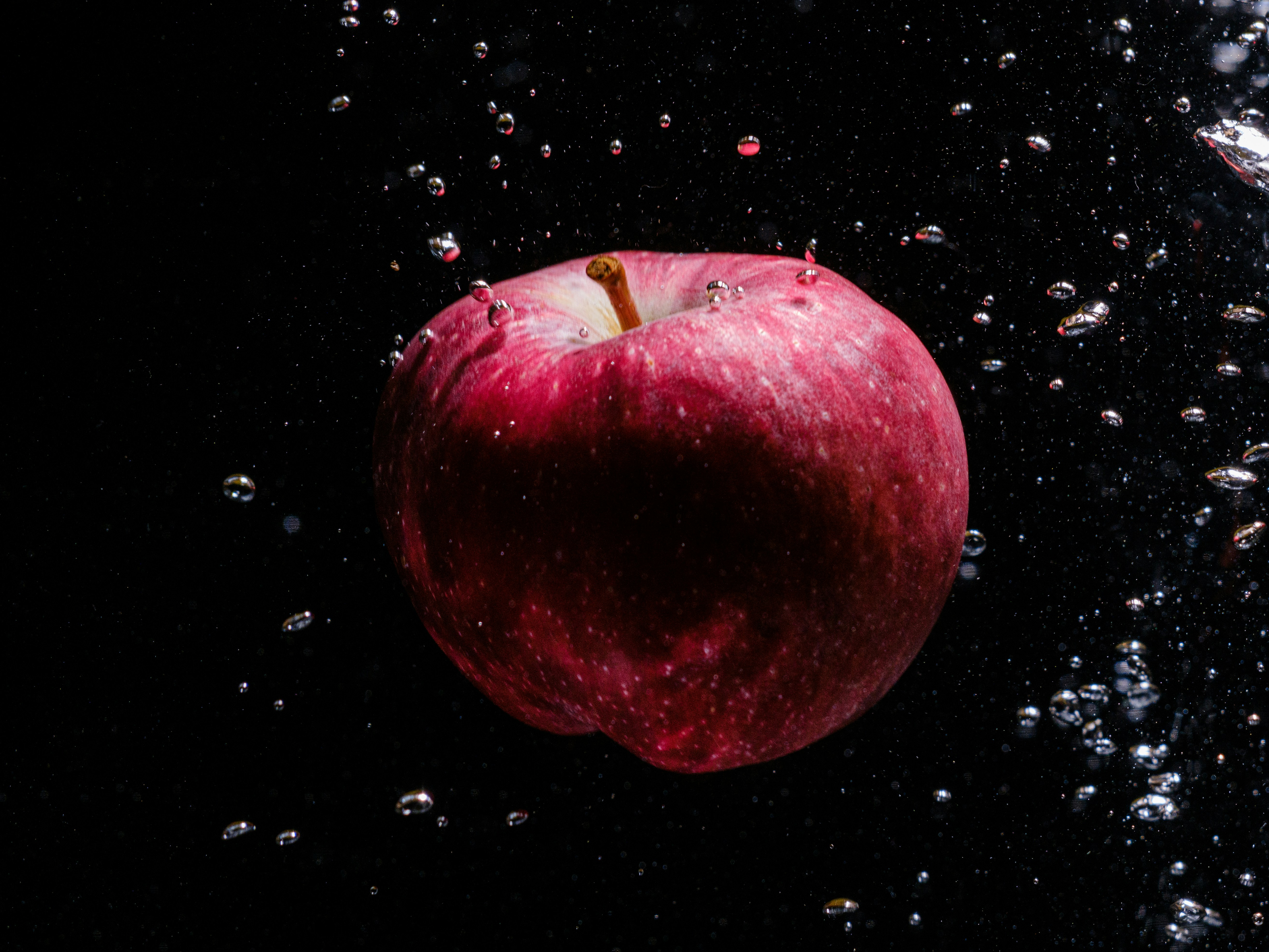 A red apple floating in water with bubbles photo – Free Background ...