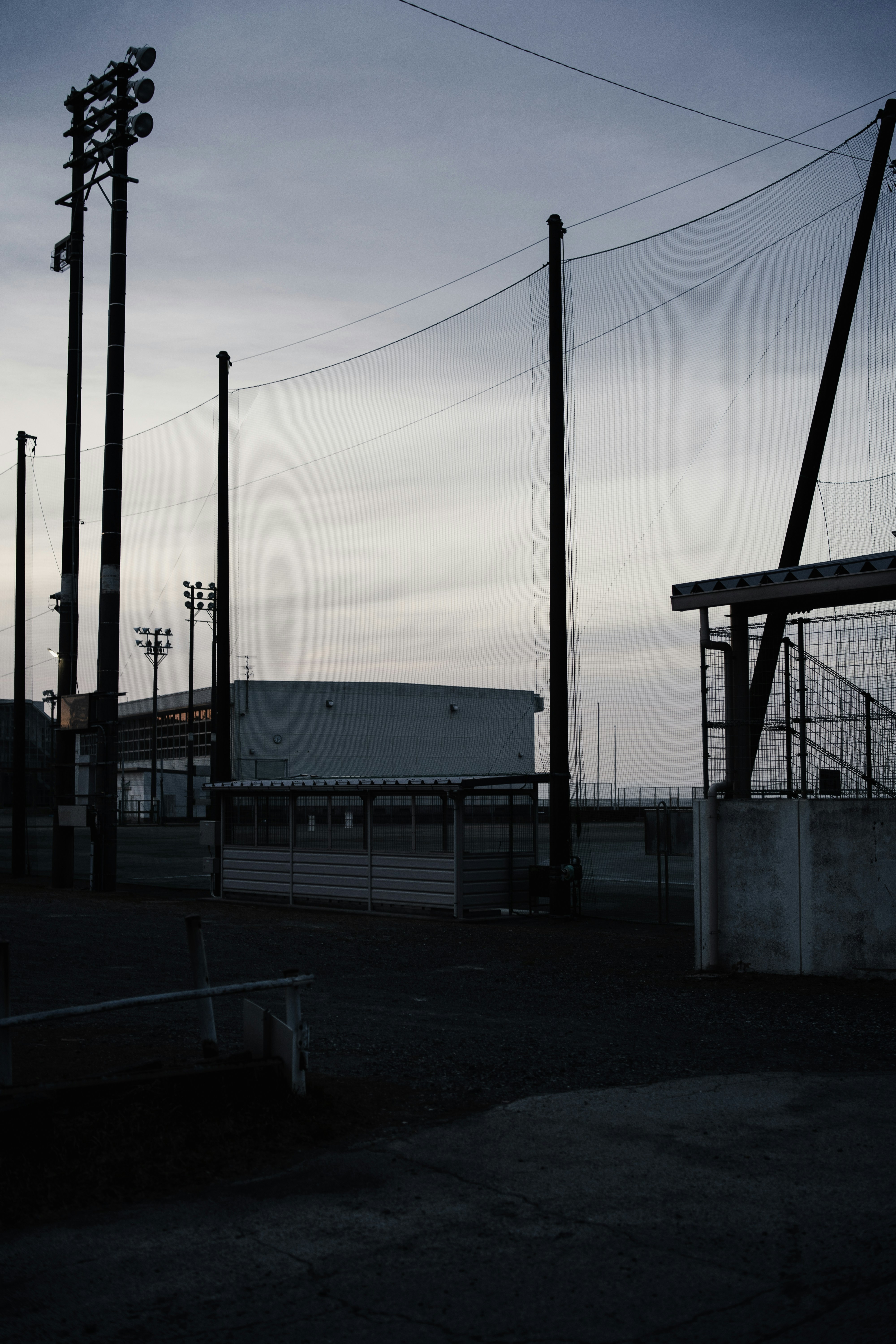 Baseball court adjacent to a school in a small coastal town in Japan where the pupils practice during the day.