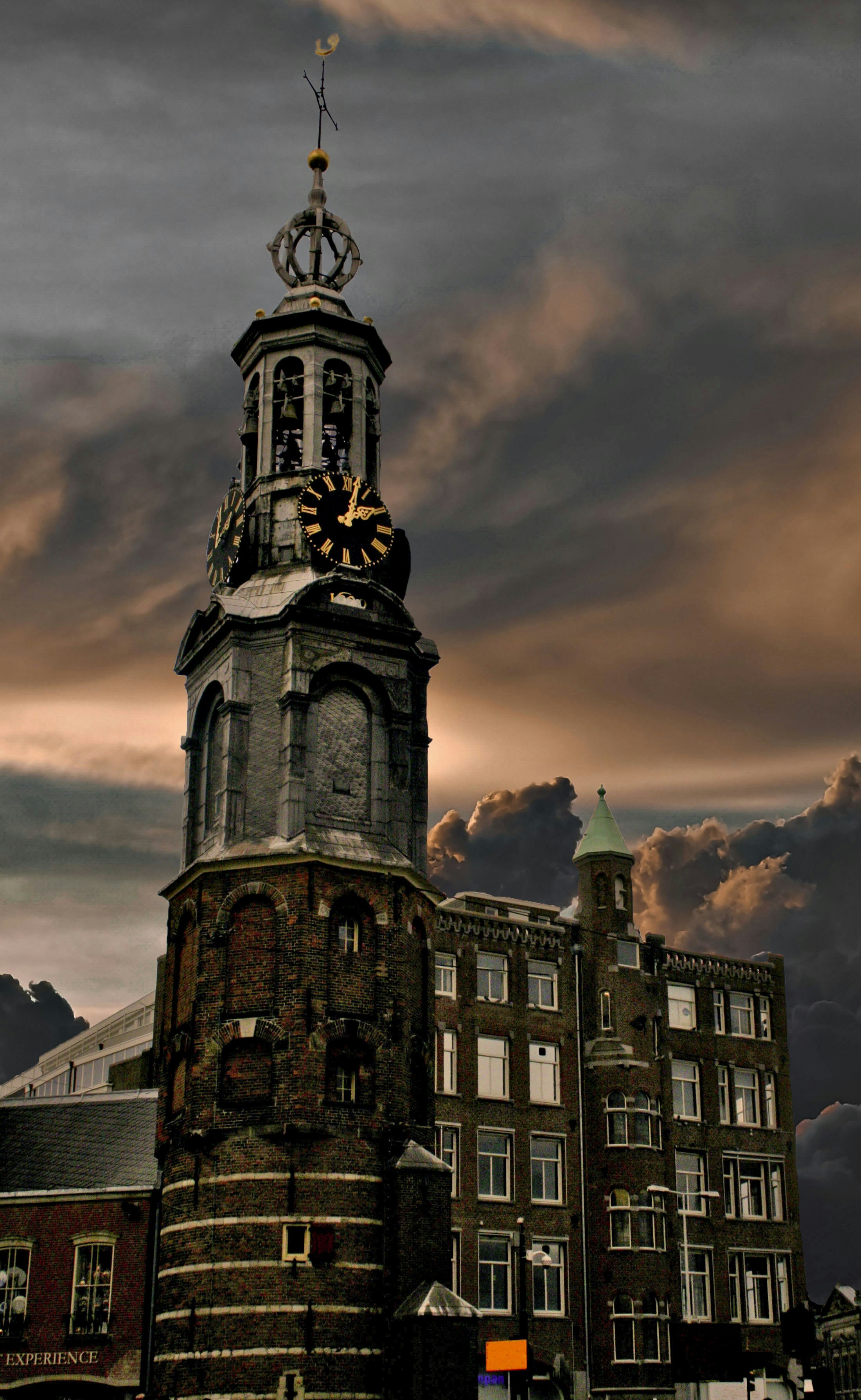 Clocktower at Dusk: Brick Spire beneath a Fiery Sunset