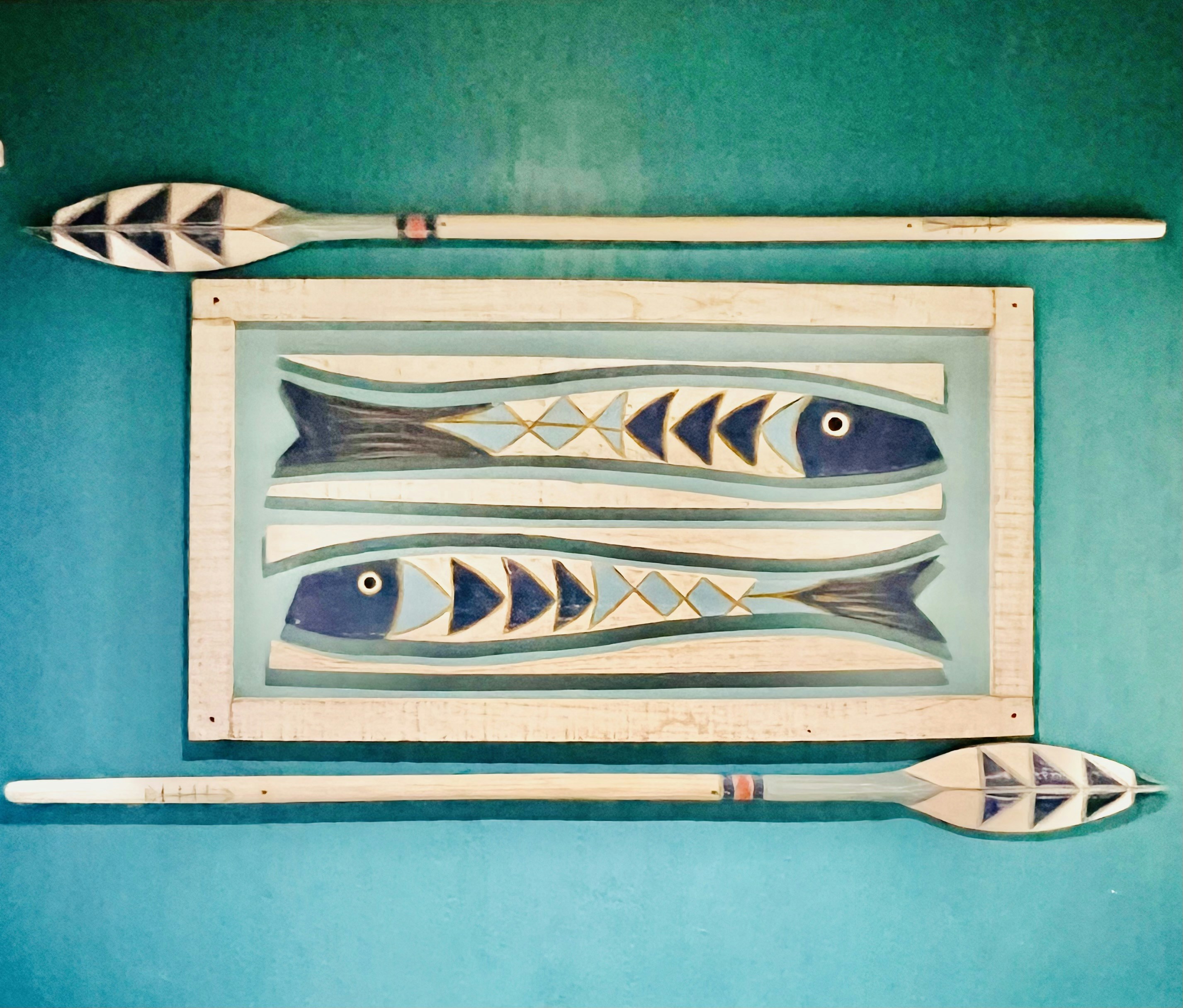 Teal Still-Life: Twin Blue Fish Framed by Oars