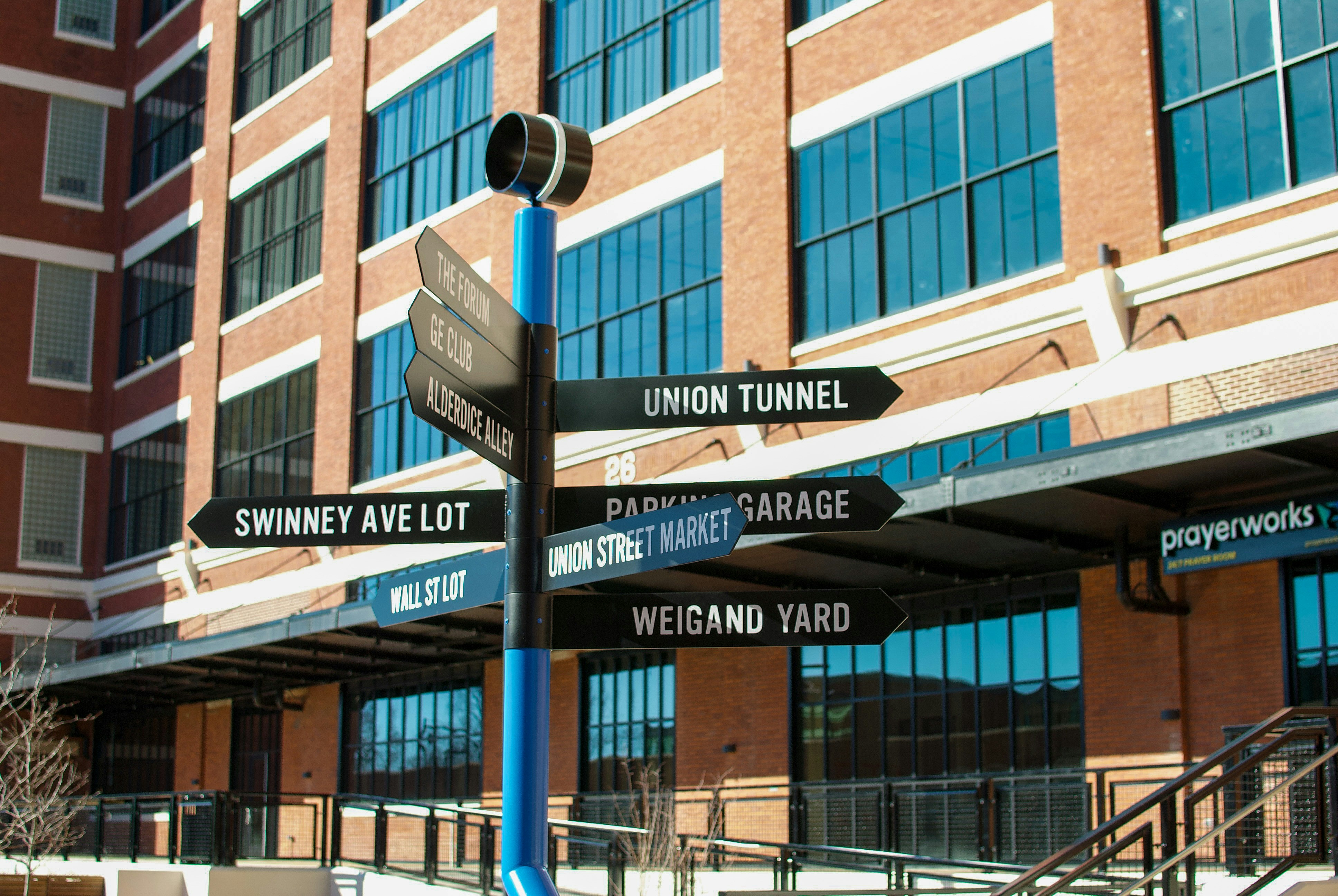 A pole with many street signs in front of a building photo – Free City ...