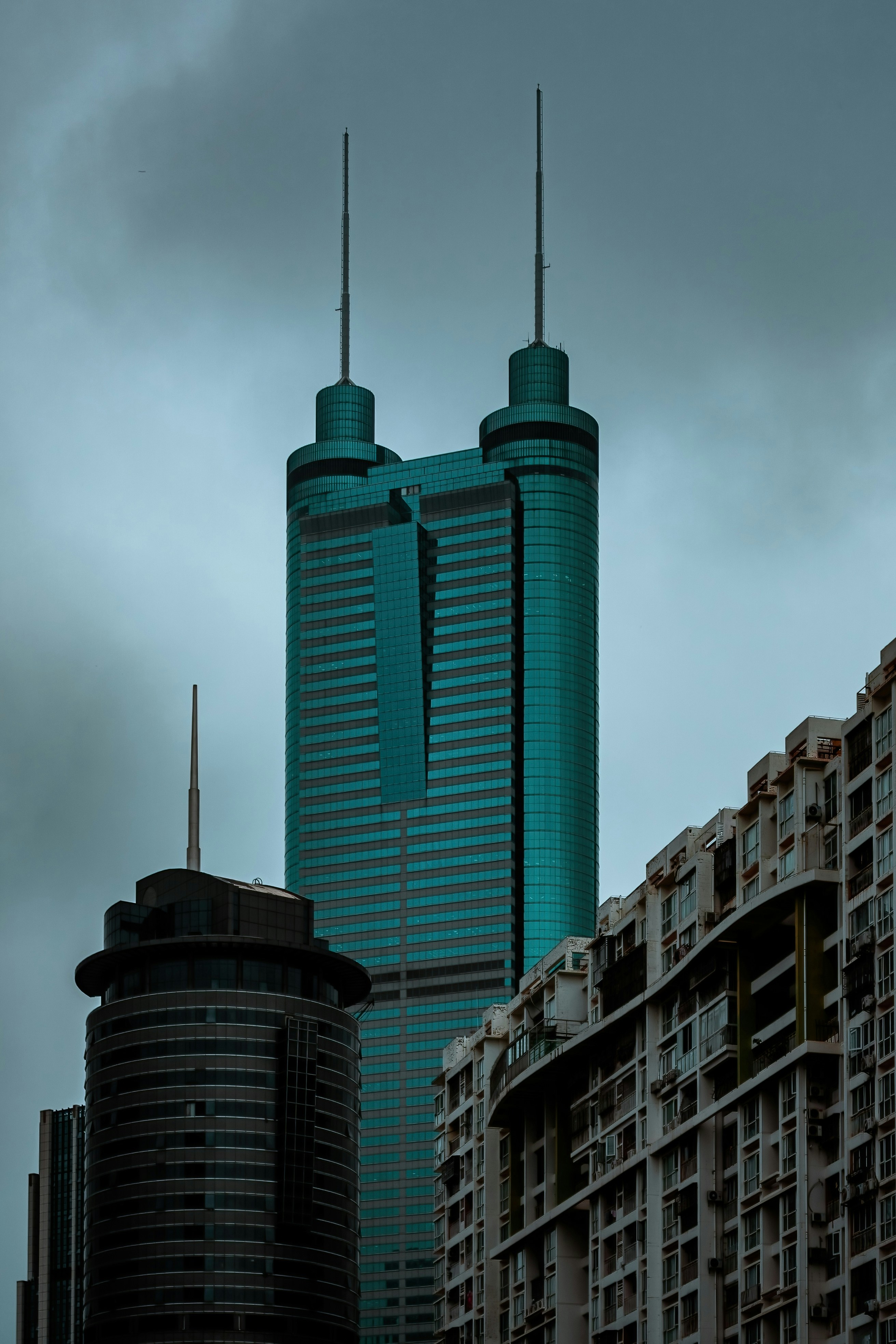 Teal Twin Towers Over a Terraced Cityscape