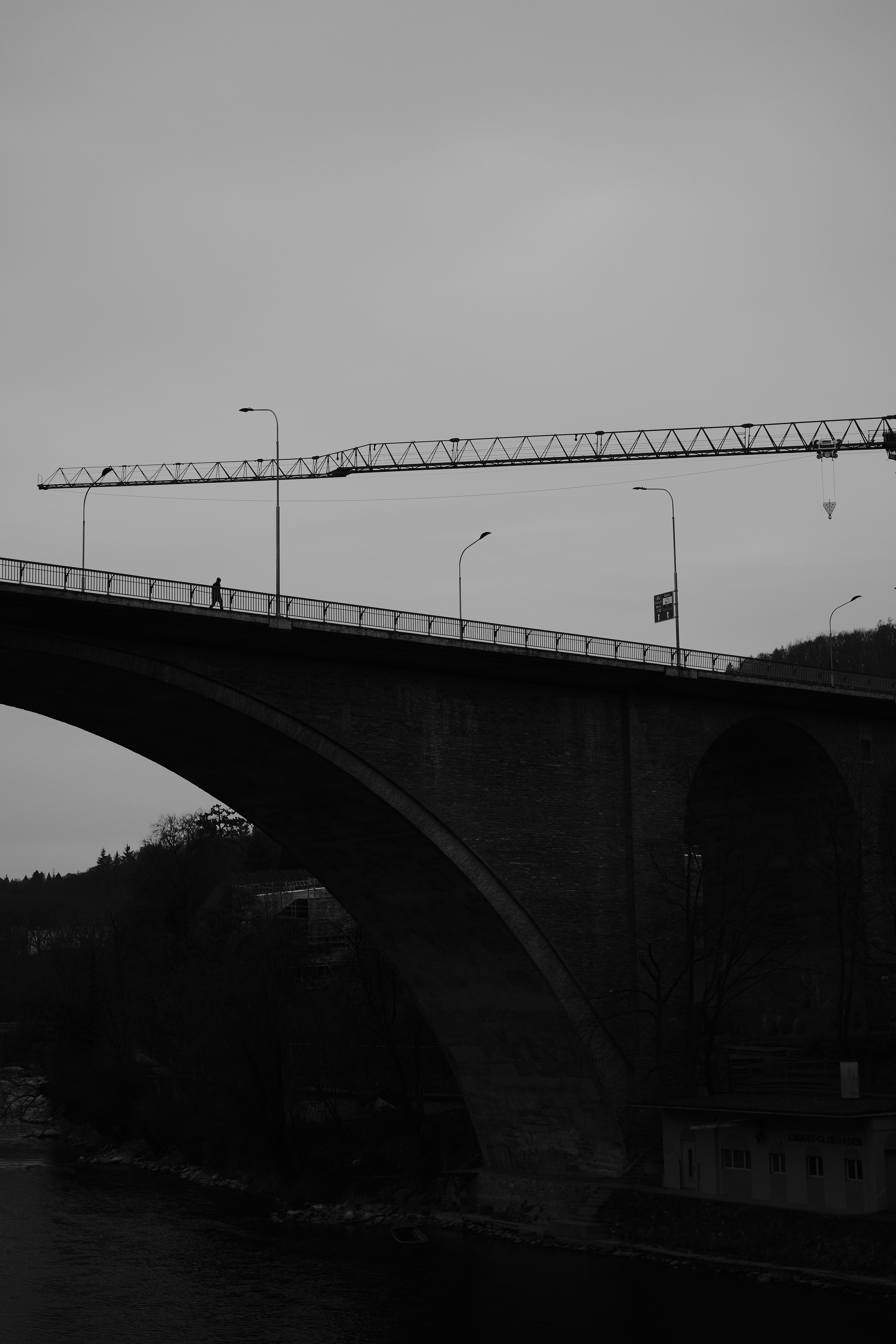 a bridge over a body of water under a cloudy sky