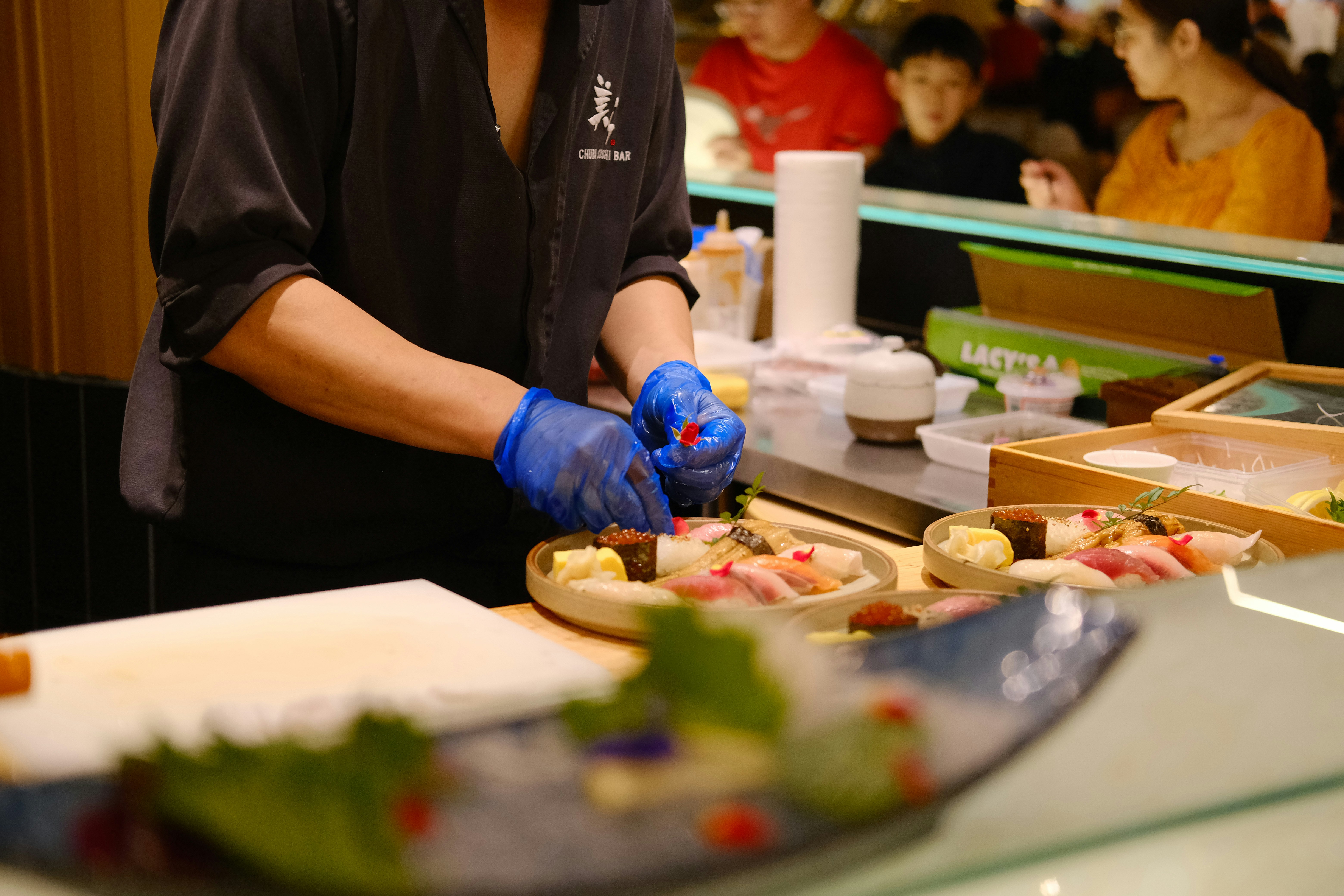 Blue-Gloved Precision: Sushi Plating in a Live Kitchen