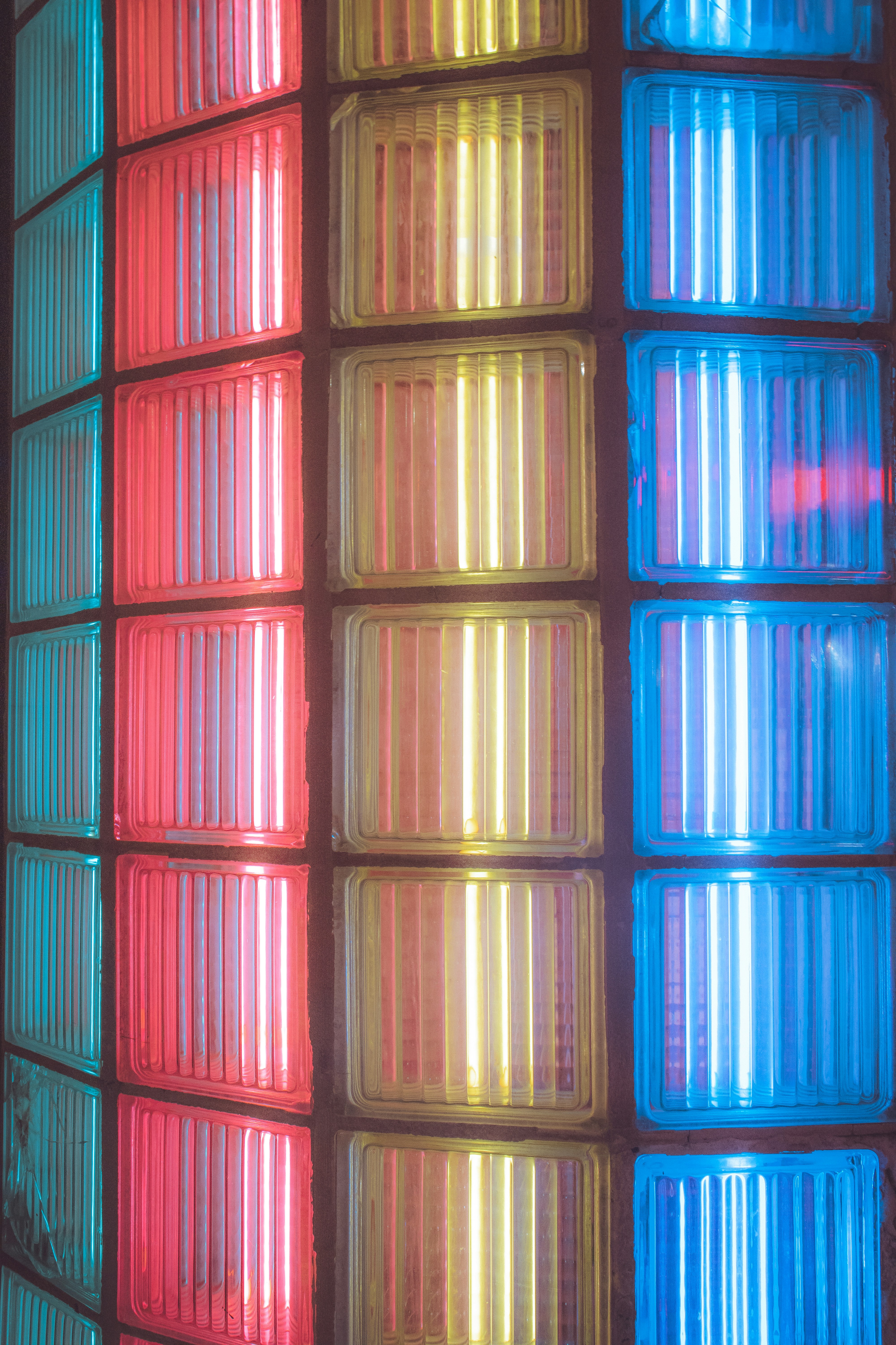 a close up of a multi colored glass block wall